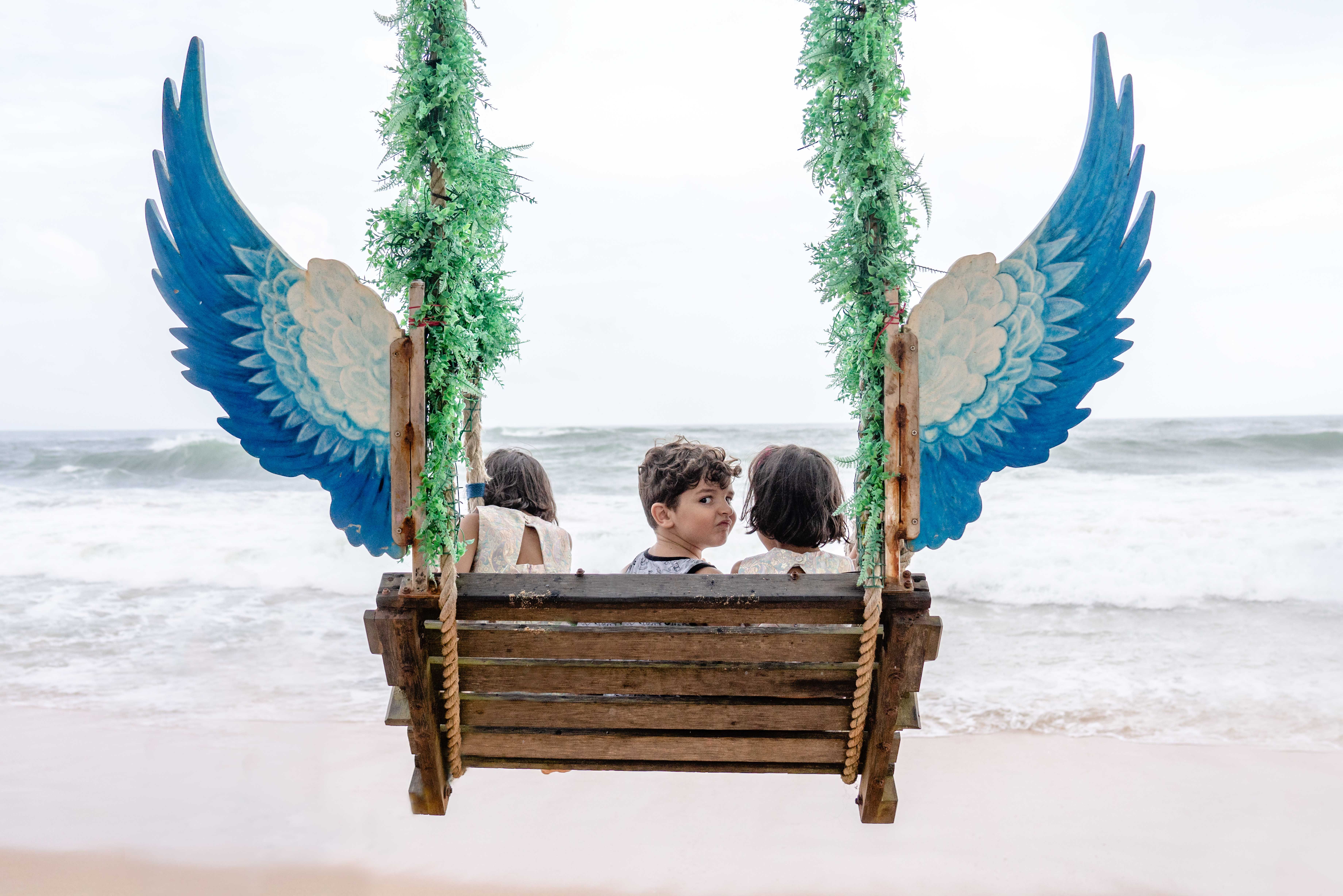 A Boy Looking Back while Sitting on a Swing · Free Stock Photo
