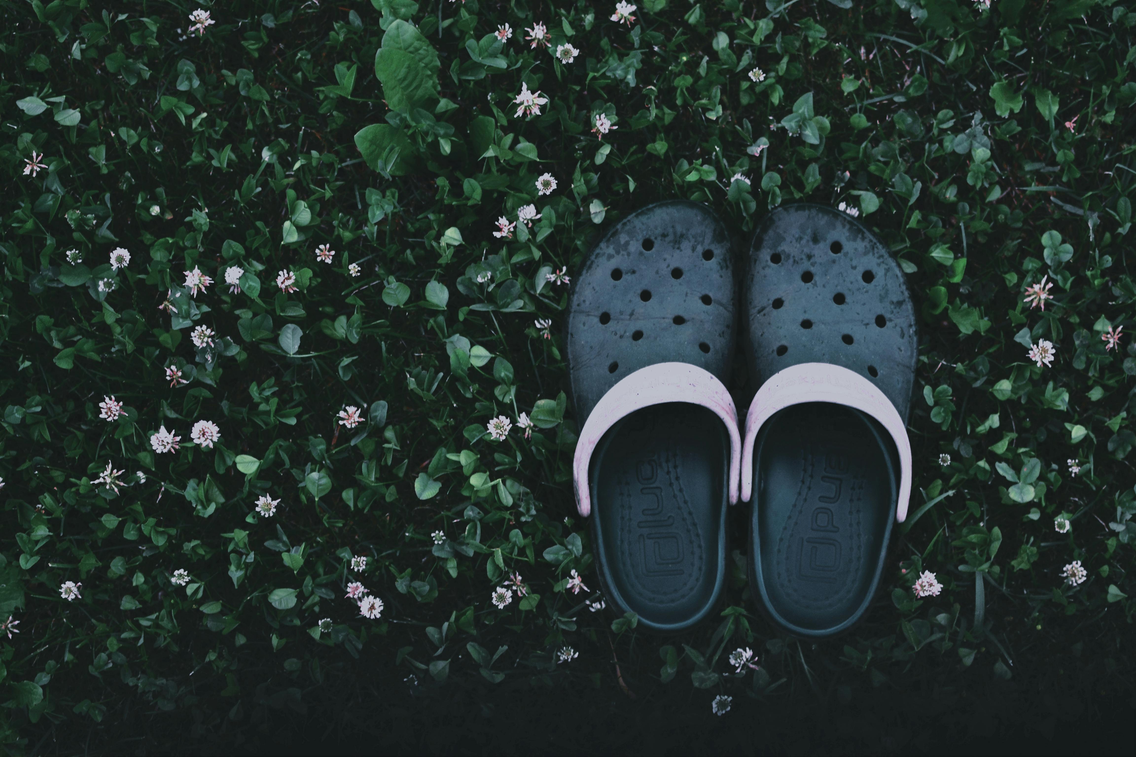 Top View Photo of Slippers On Seashore · Free Stock Photo