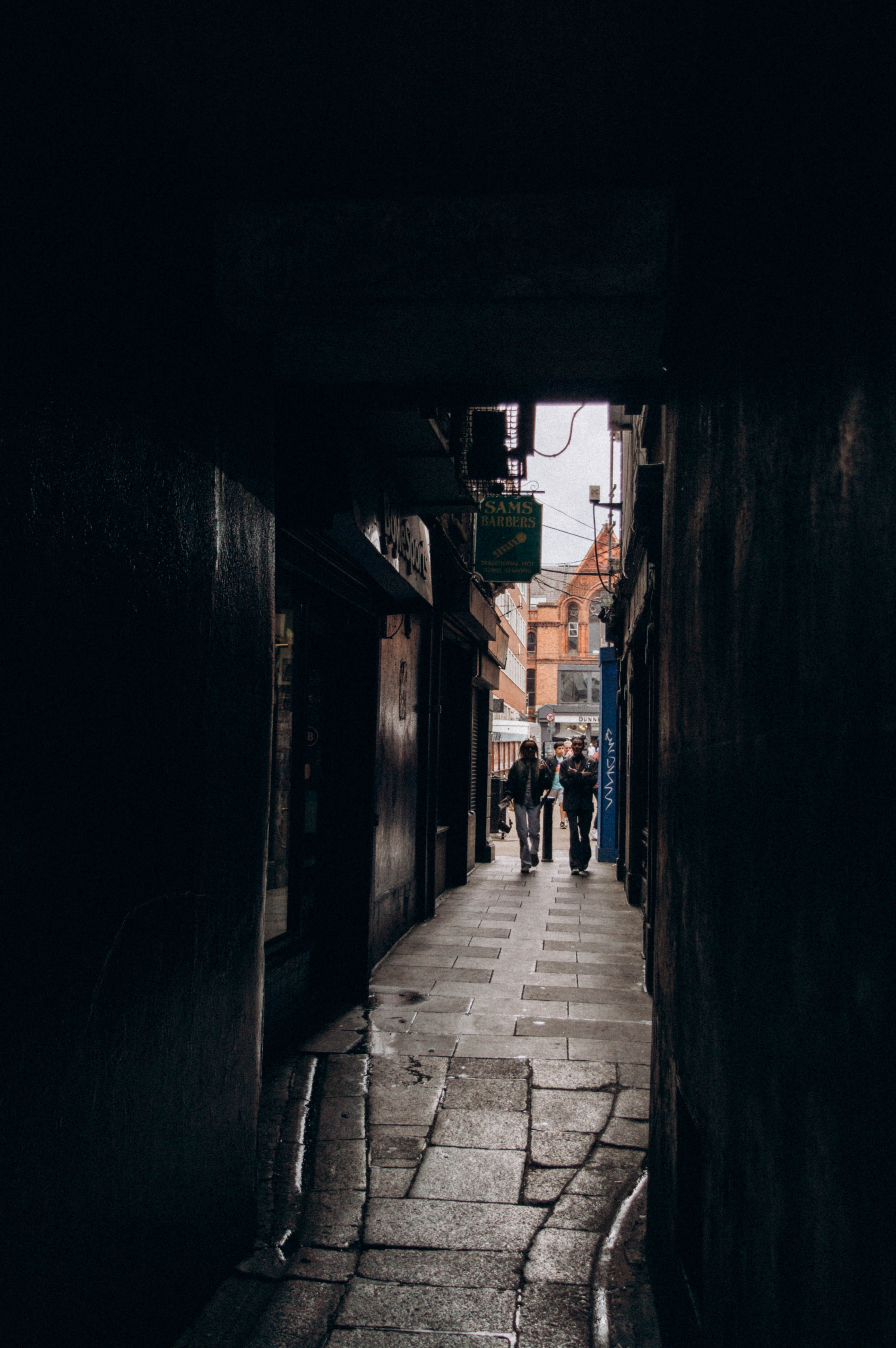 Two People Walking on Alleyway between Concrete Buildings · Free Stock ...