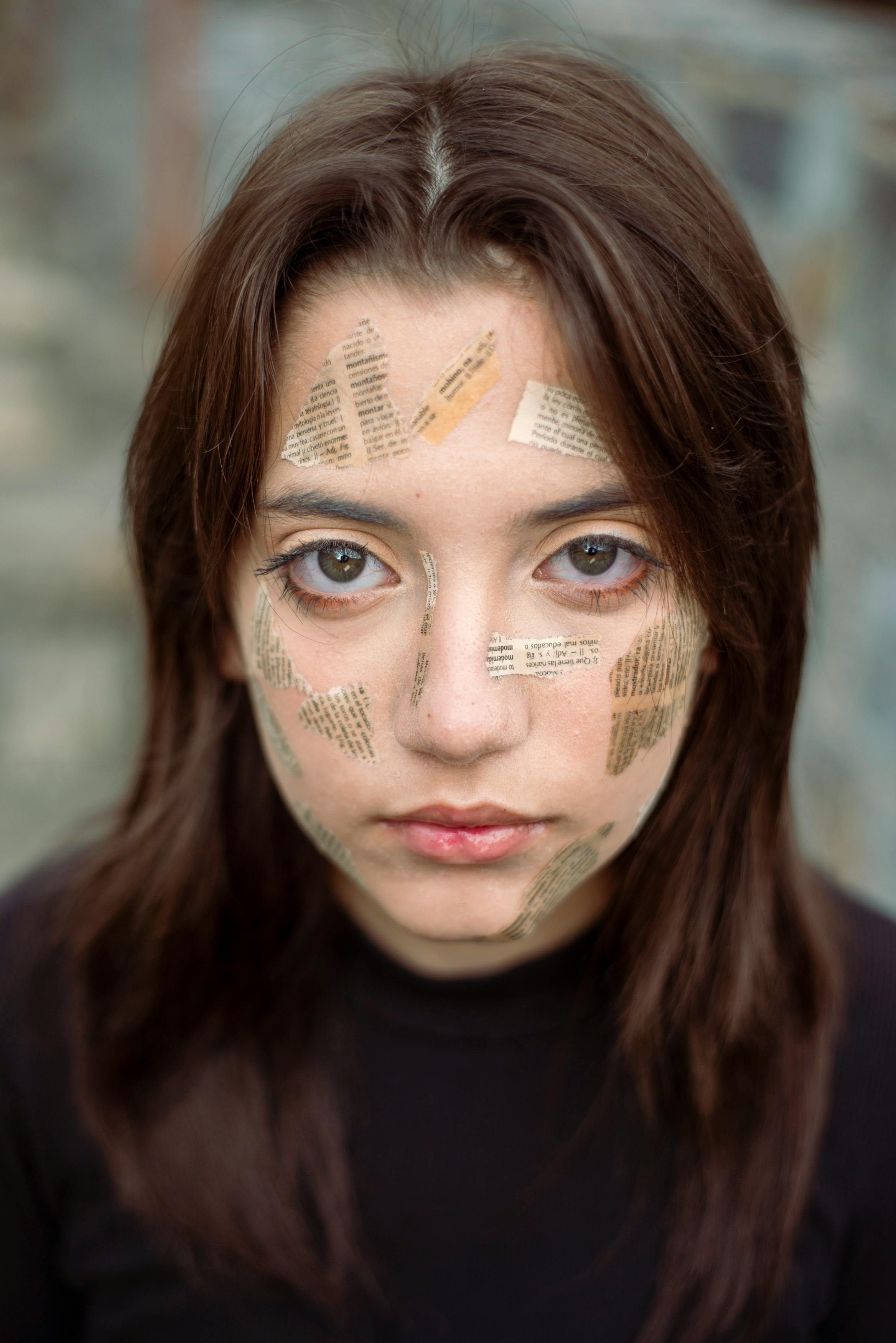 Photo of a Woman Tearing Blue Paper · Free Stock Photo