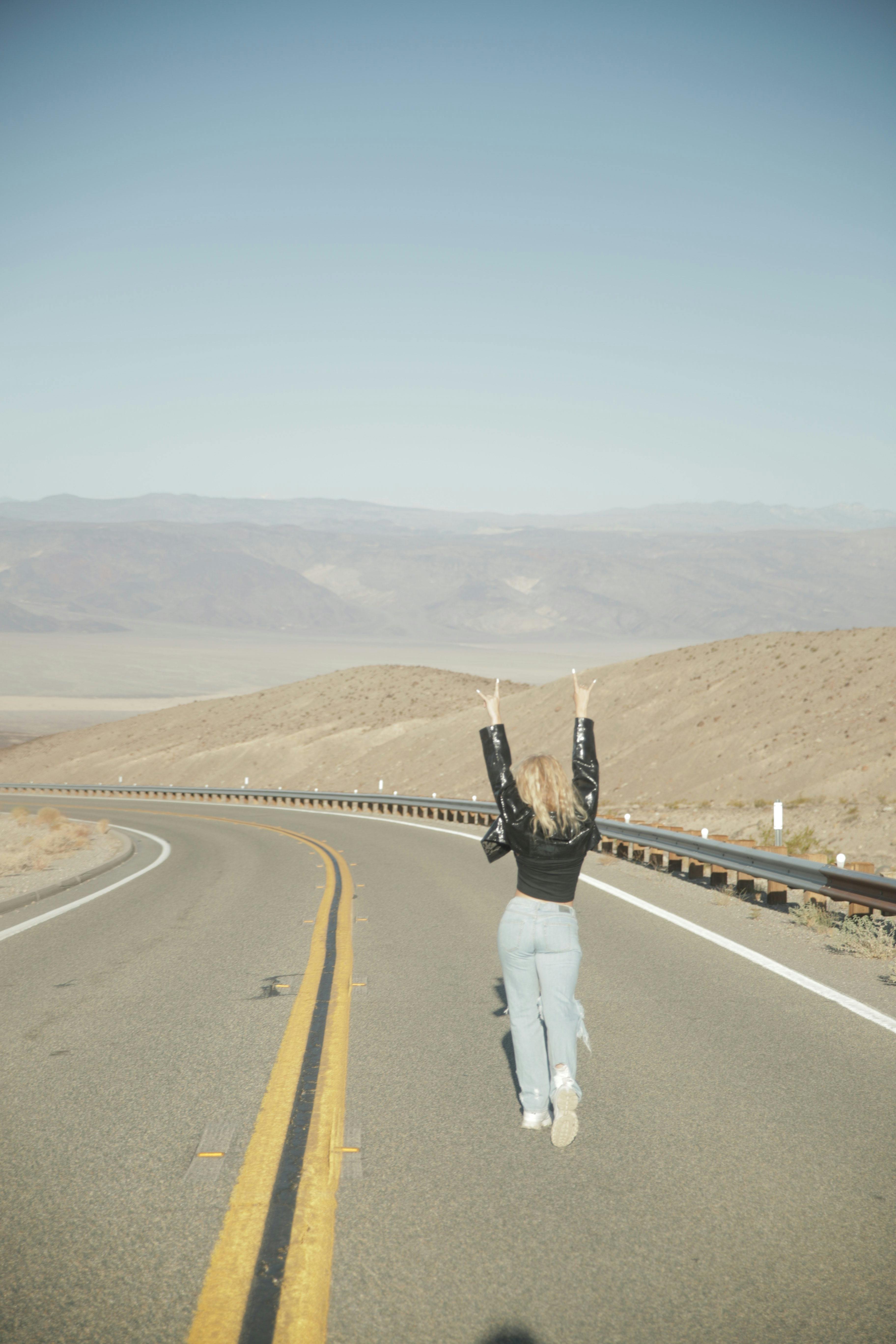 Back View of a Woman Walking on a Road · Free Stock Photo