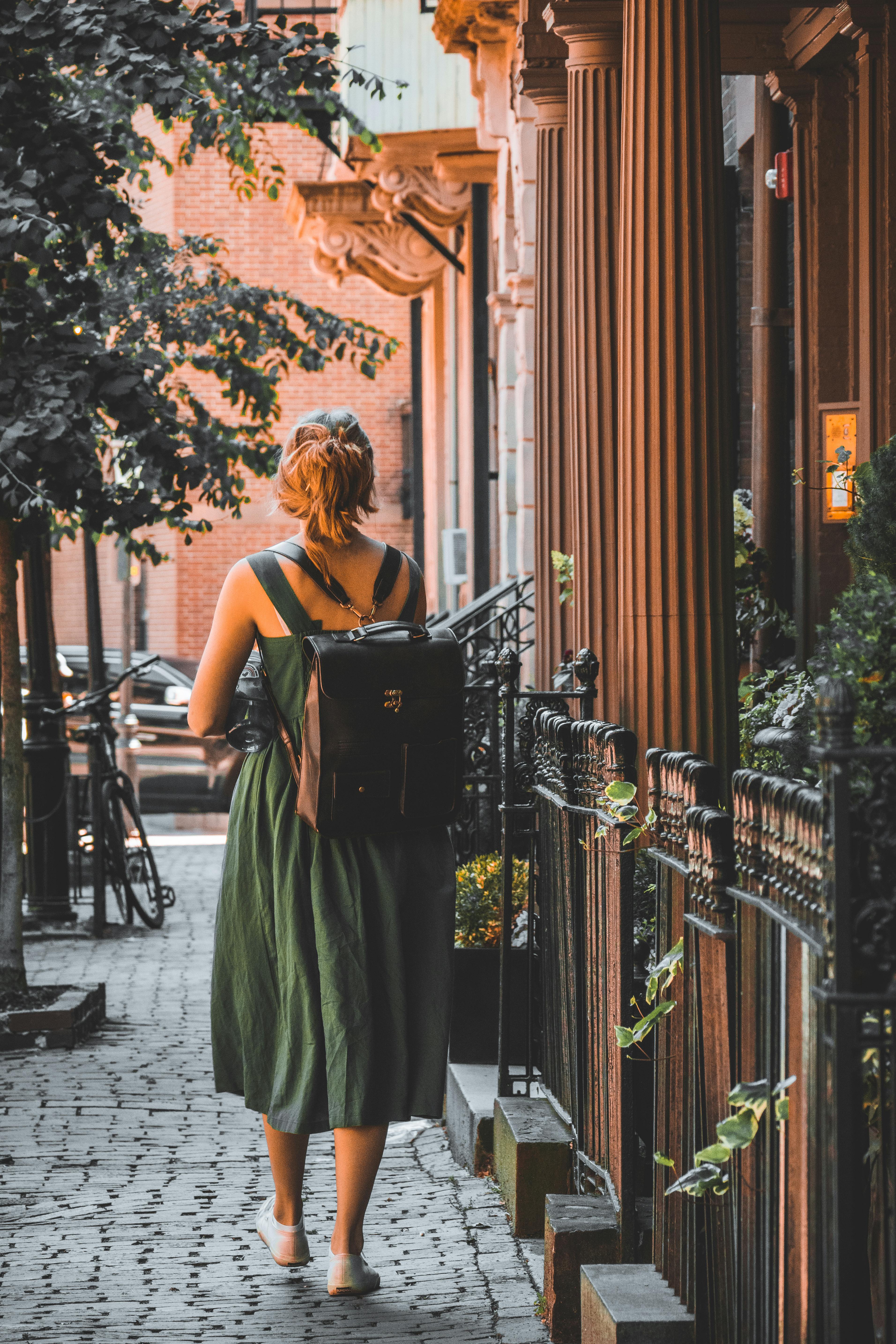 A Woman Carrying a Brown Leather Rucksack · Free Stock Photo