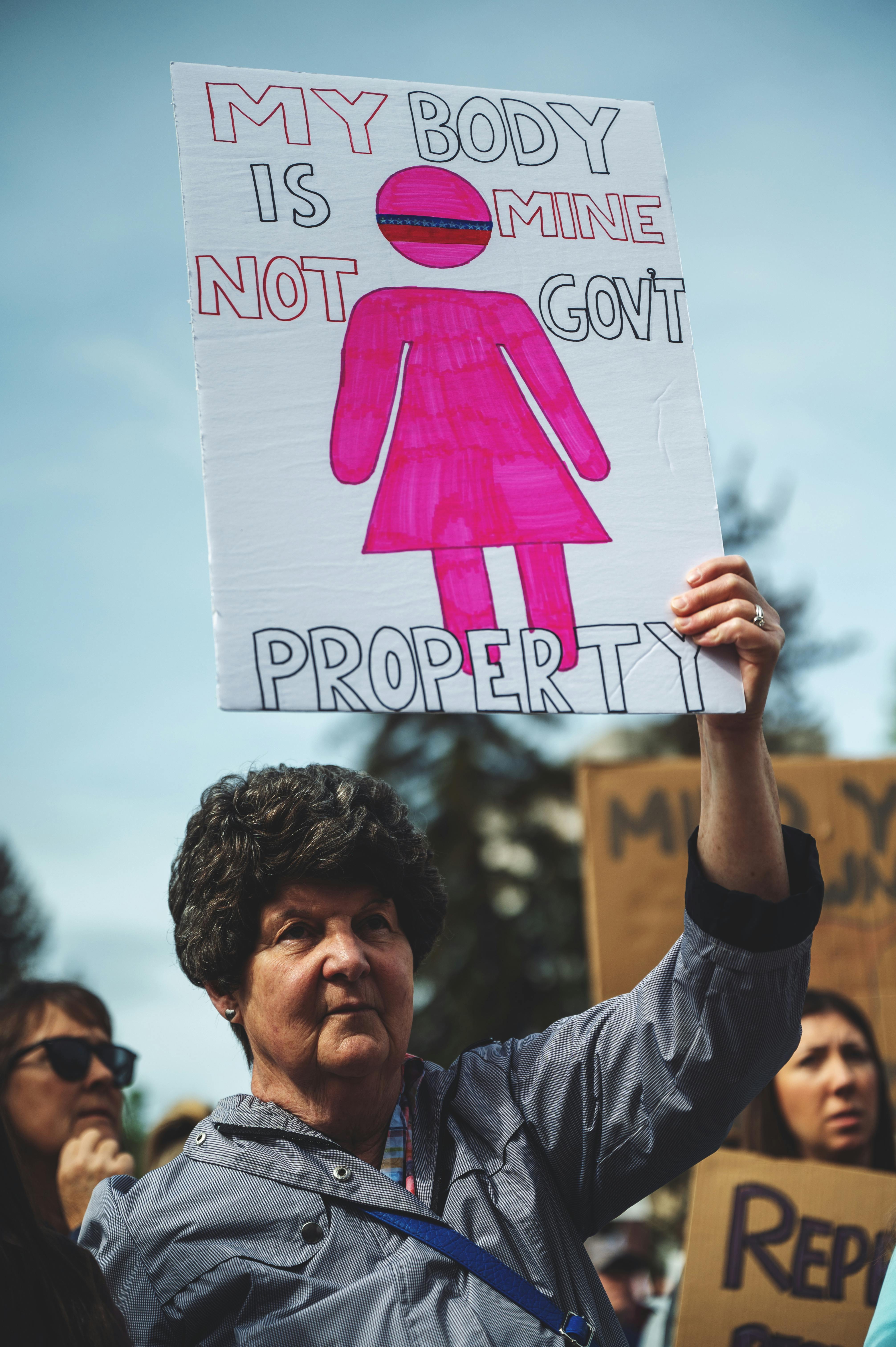 Woman Holding Banner during Protest · Free Stock Photo