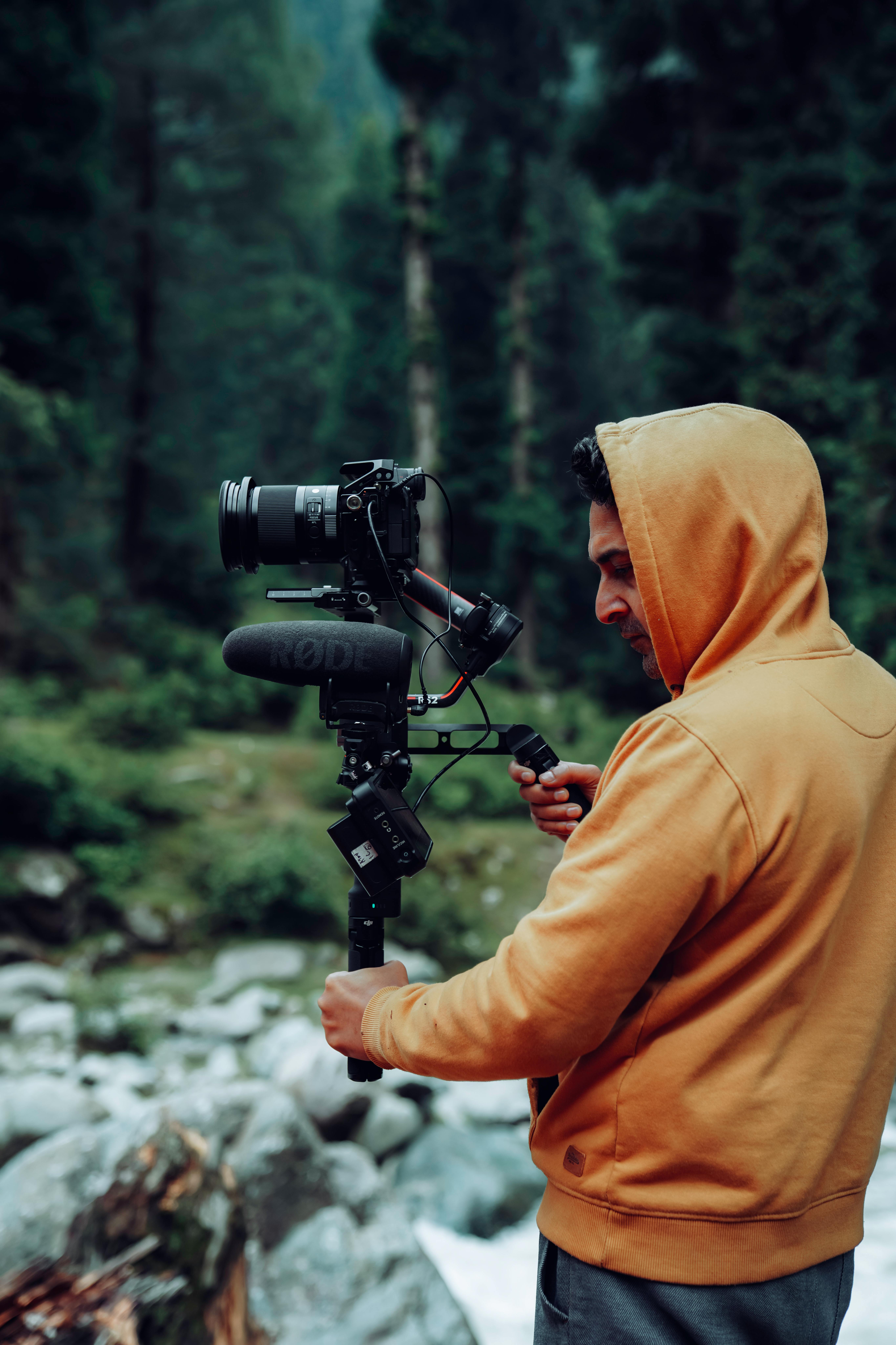 Camera Man With Video Camera on Tripod Position by the Street Across ...