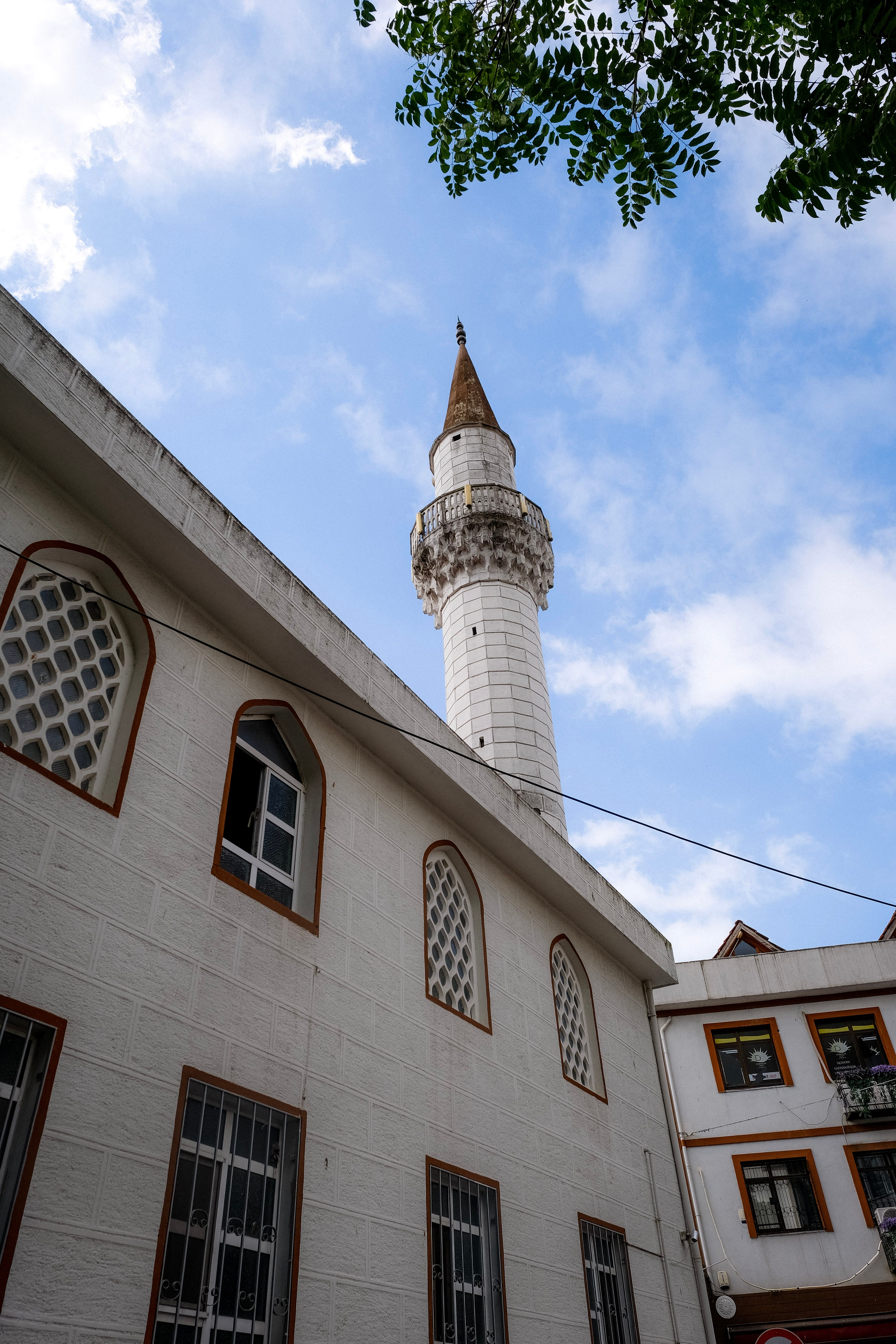 Minaret Towering above Buildings · Free Stock Photo
