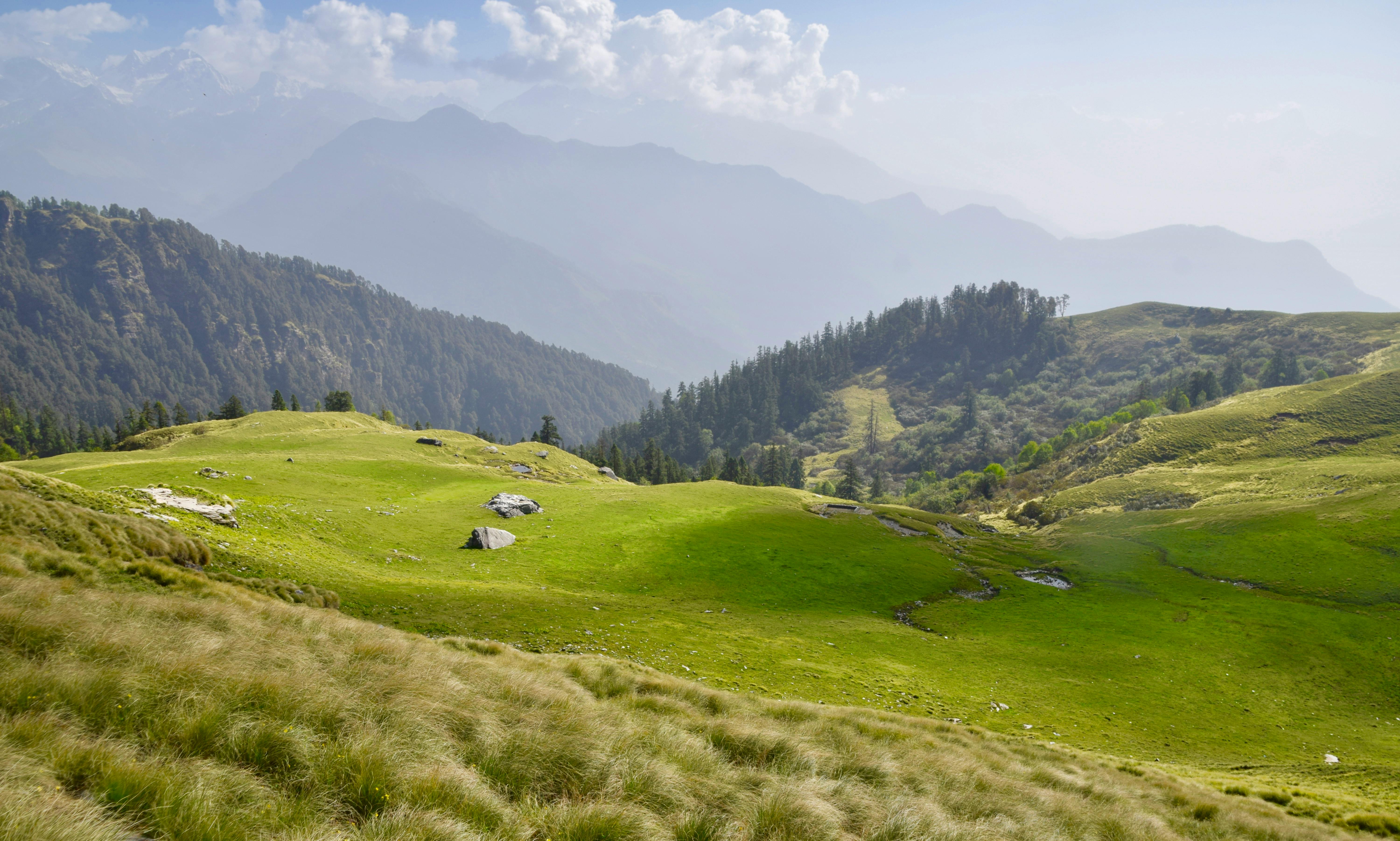 A Field with Mountains in the Background · Free Stock Photo