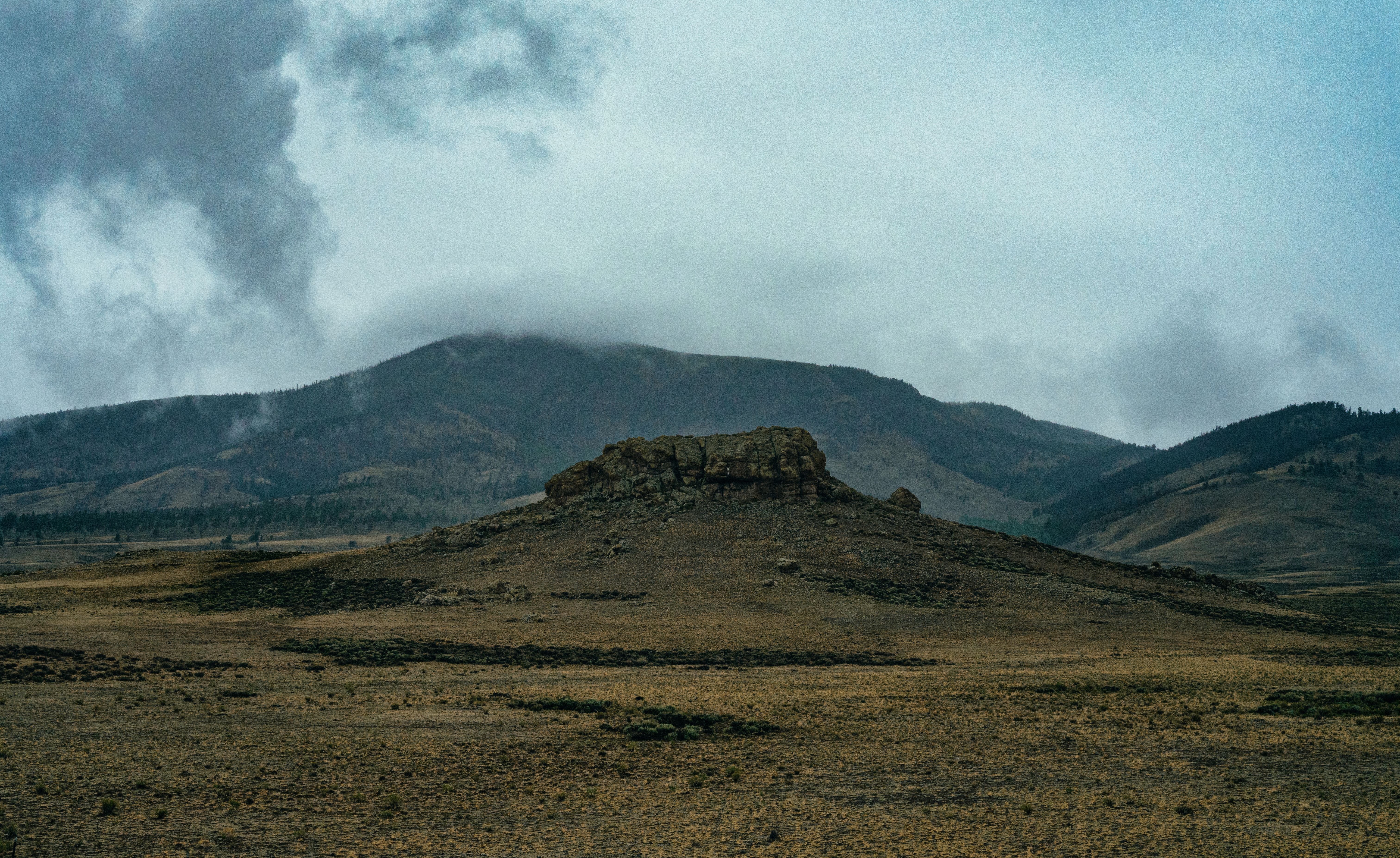 Landscape of Mountains Under a Cloudy Sky · Free Stock Photo