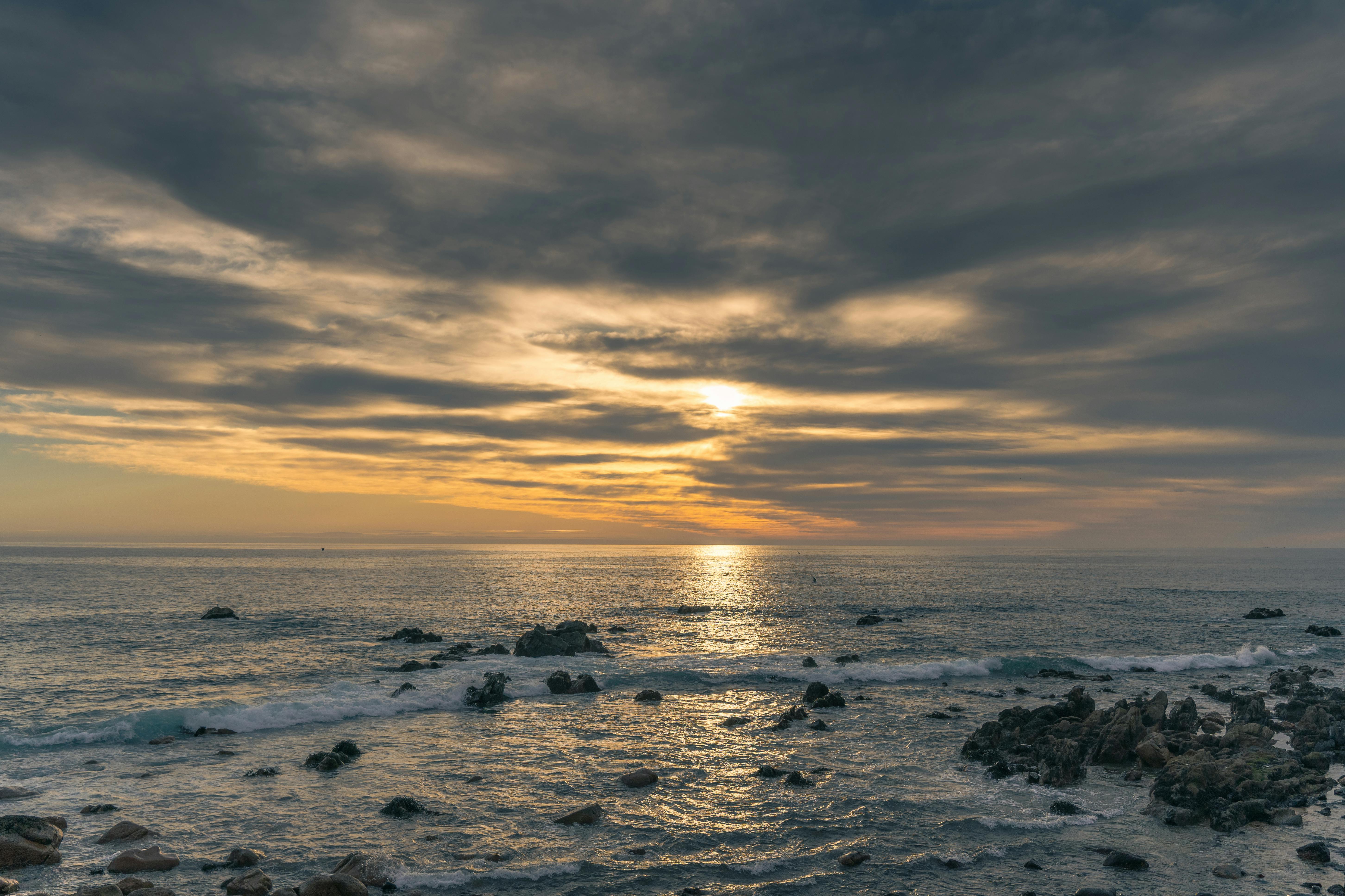 A Rocky Shore during Sunset · Free Stock Photo