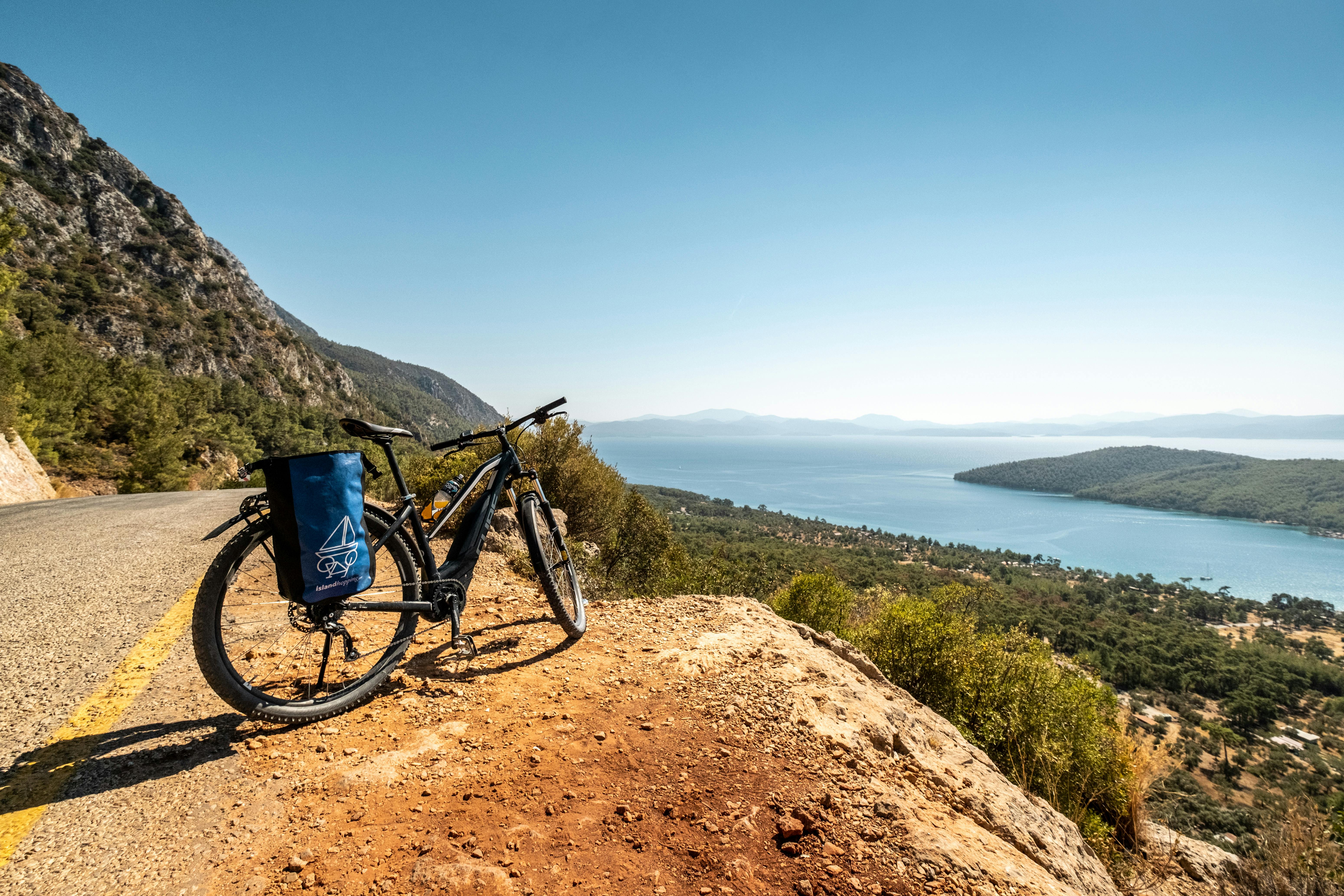 A Bicycle Parked on the Cliff Beside the Road · Free Stock Photo