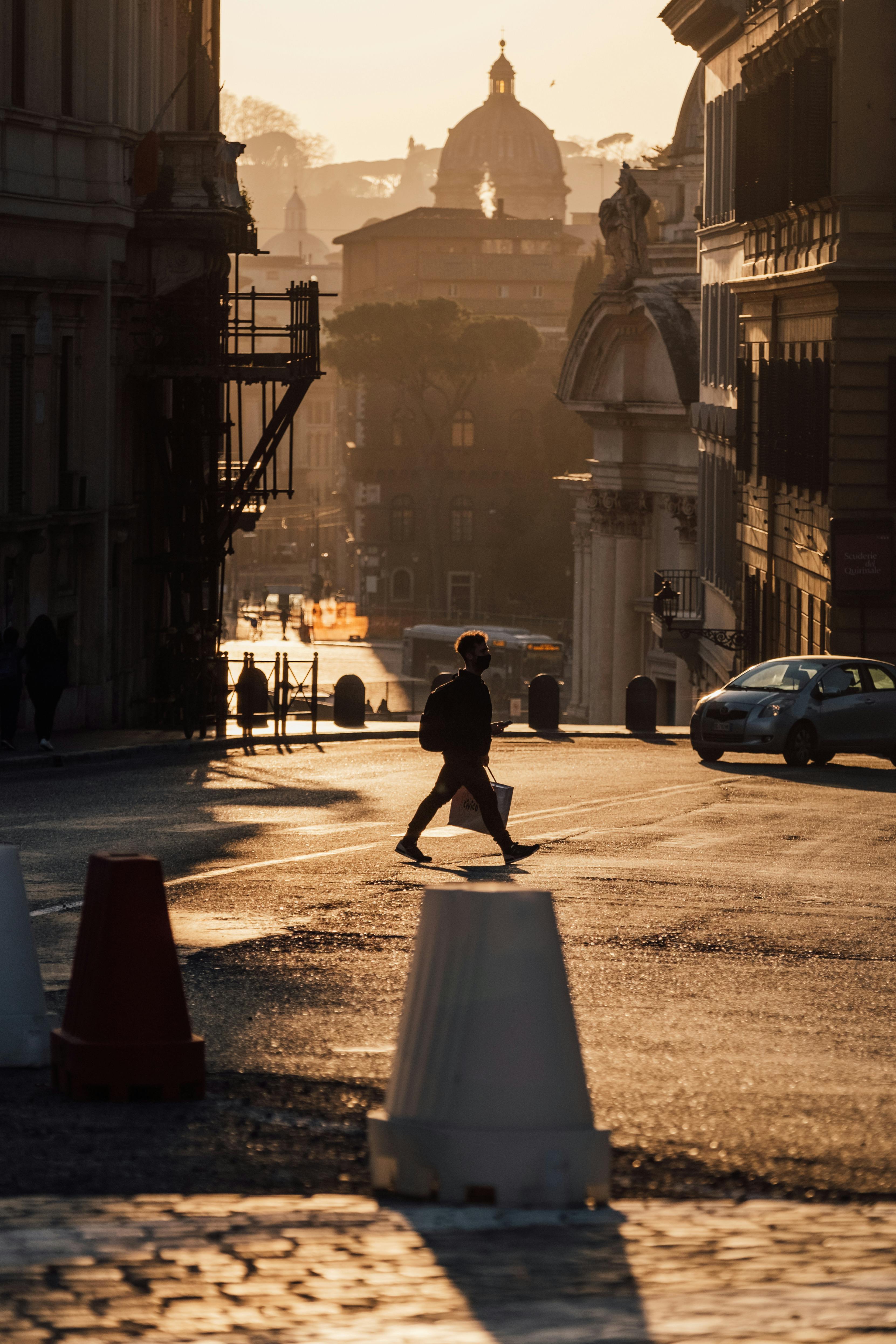 Man in Backpack Crossing on the Street · Free Stock Photo