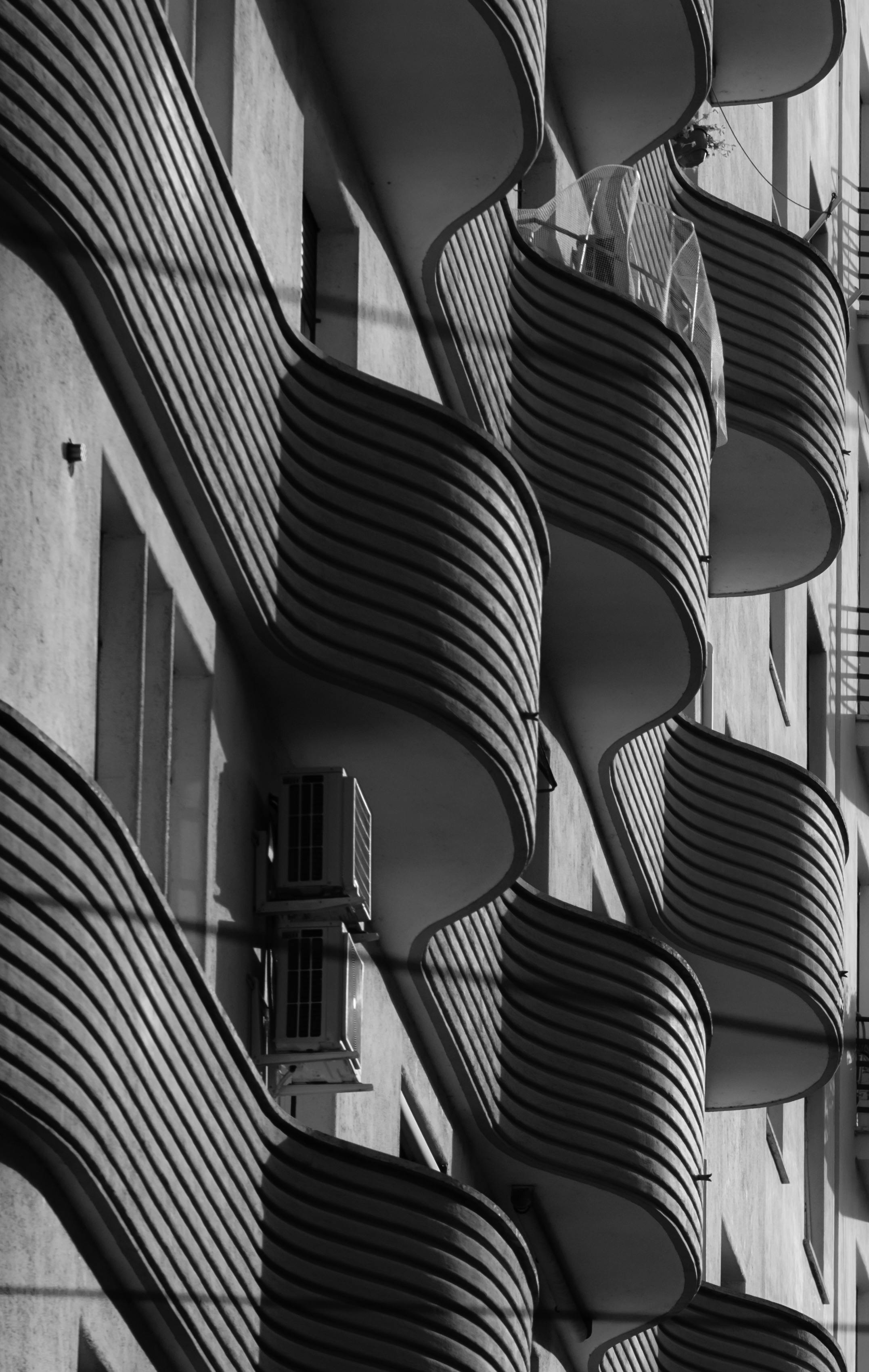 A Grayscale of a Building with Balconies · Free Stock Photo