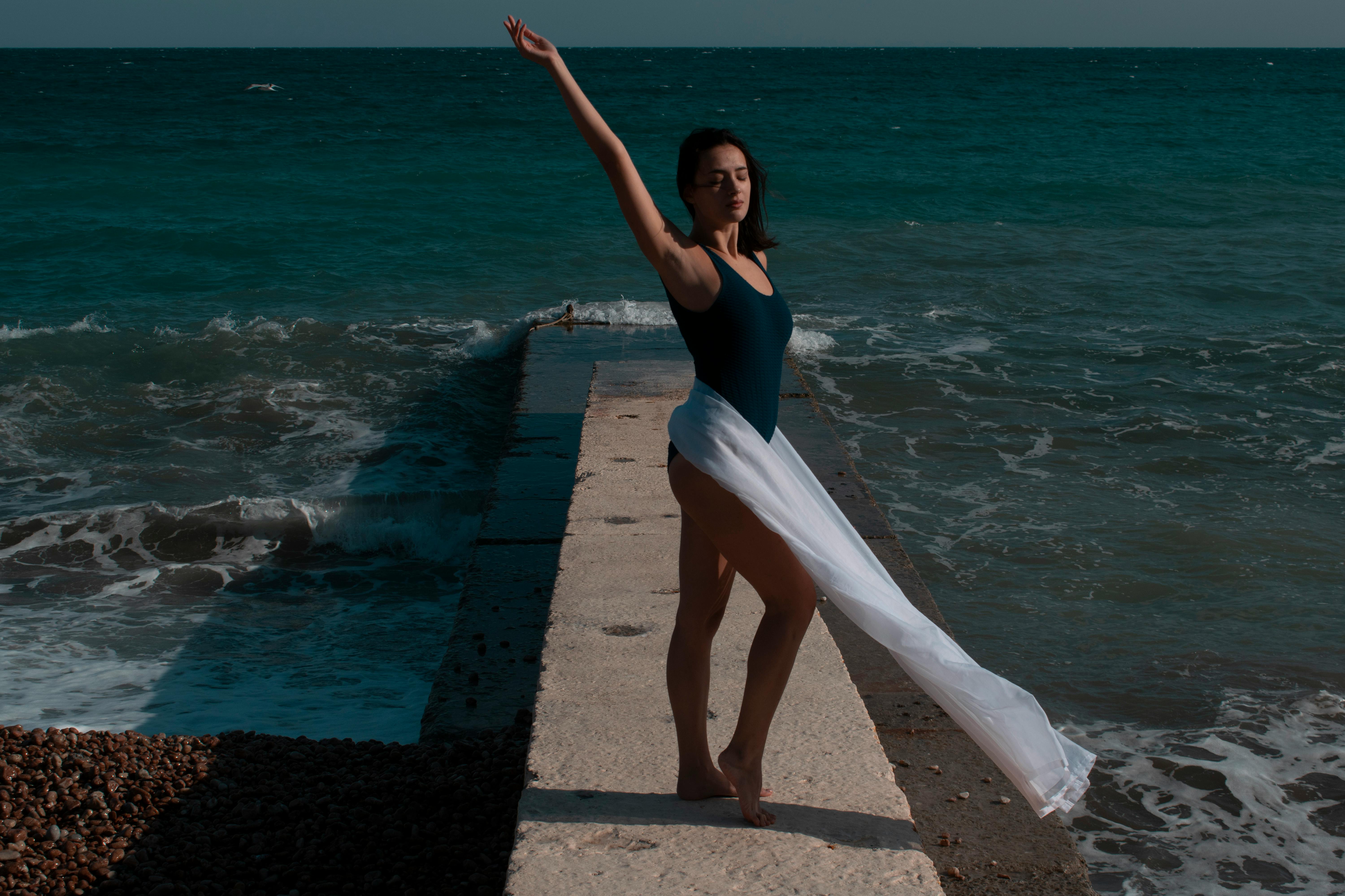 Wind Blowing the White Dress of Woman on the Beach · Free Stock Photo