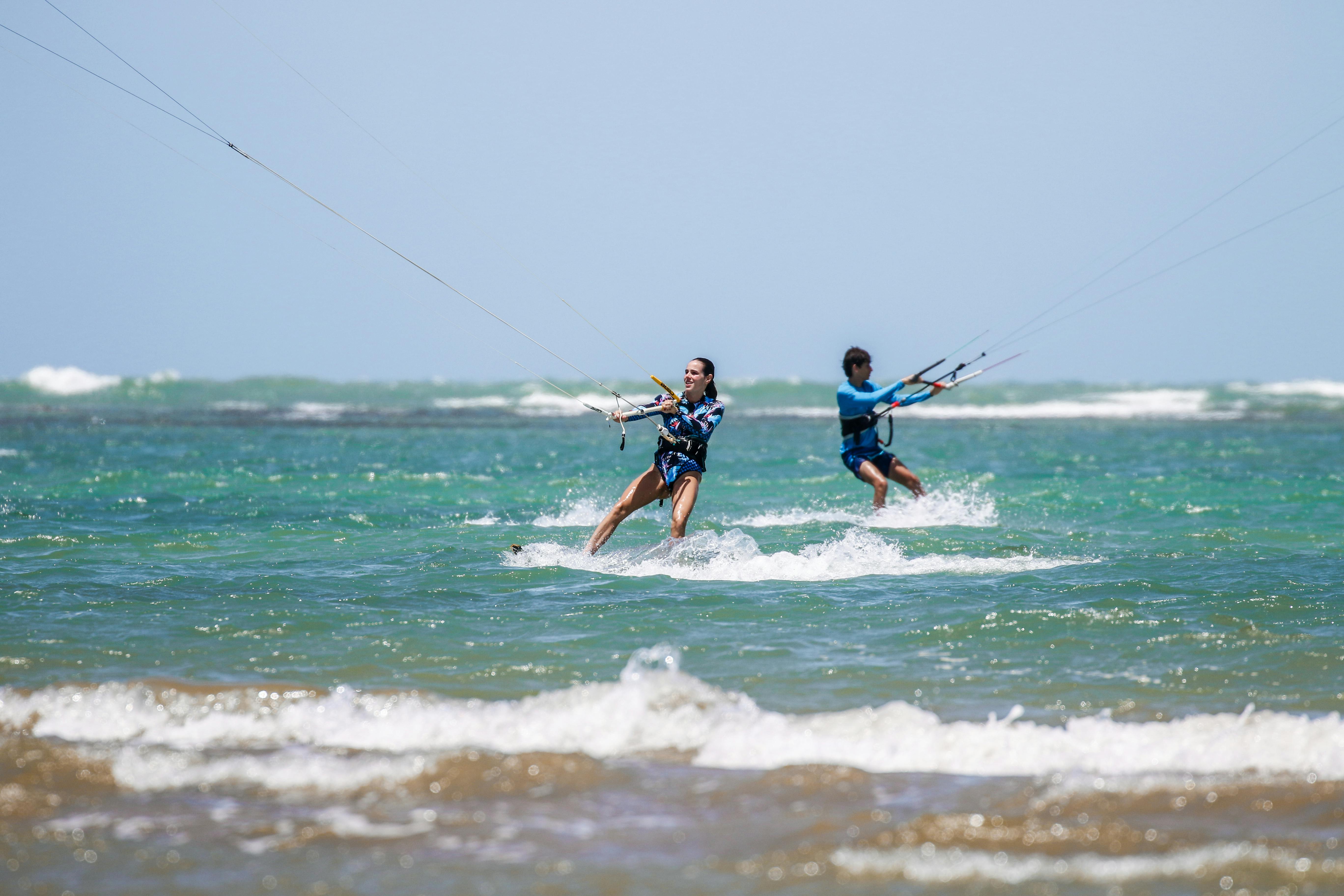 Photo of a Smiling Kitesurfing Woman with the Hand Raised and Keeping ...