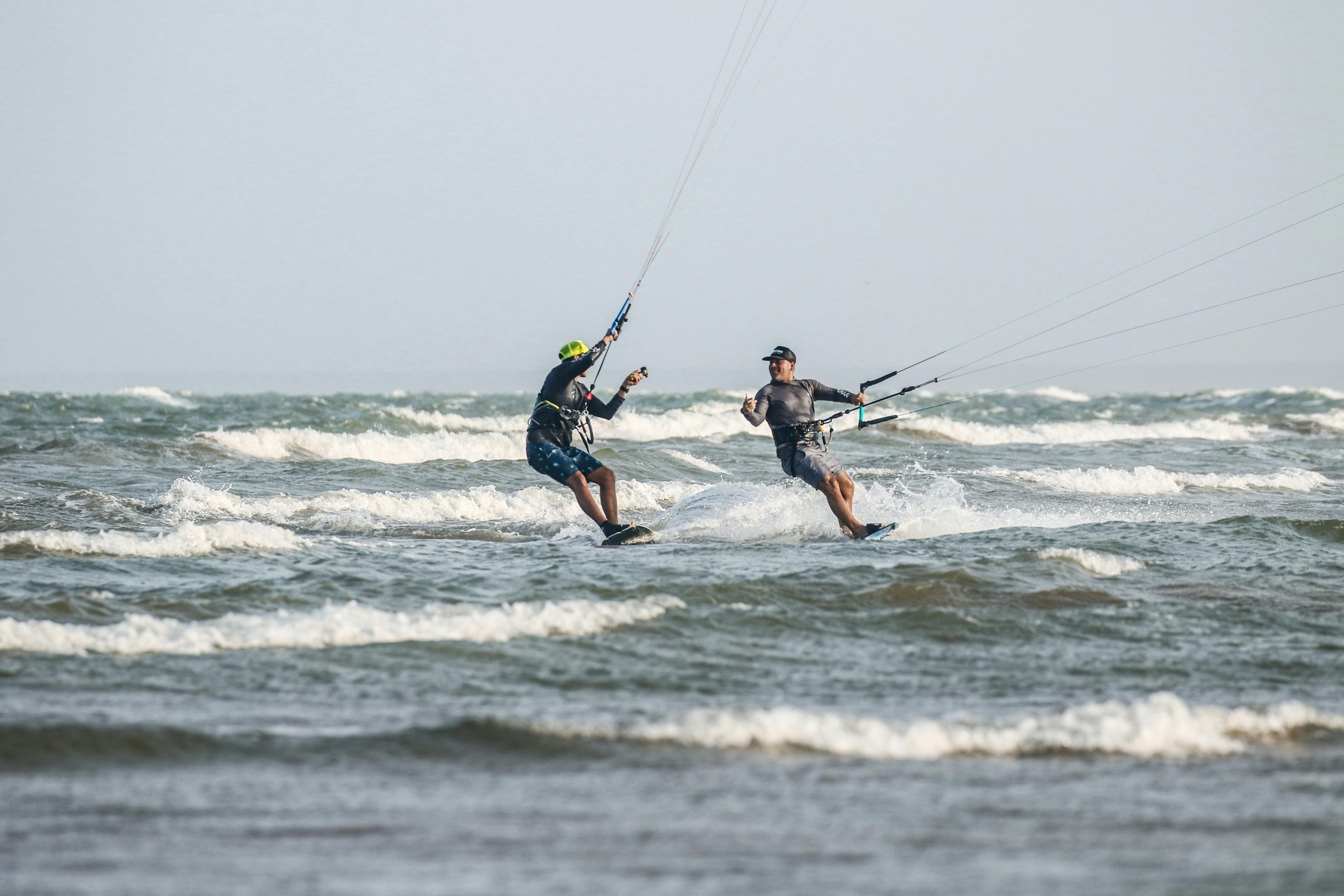 Photo of a Smiling Kitesurfing Woman with the Hand Raised and Keeping ...