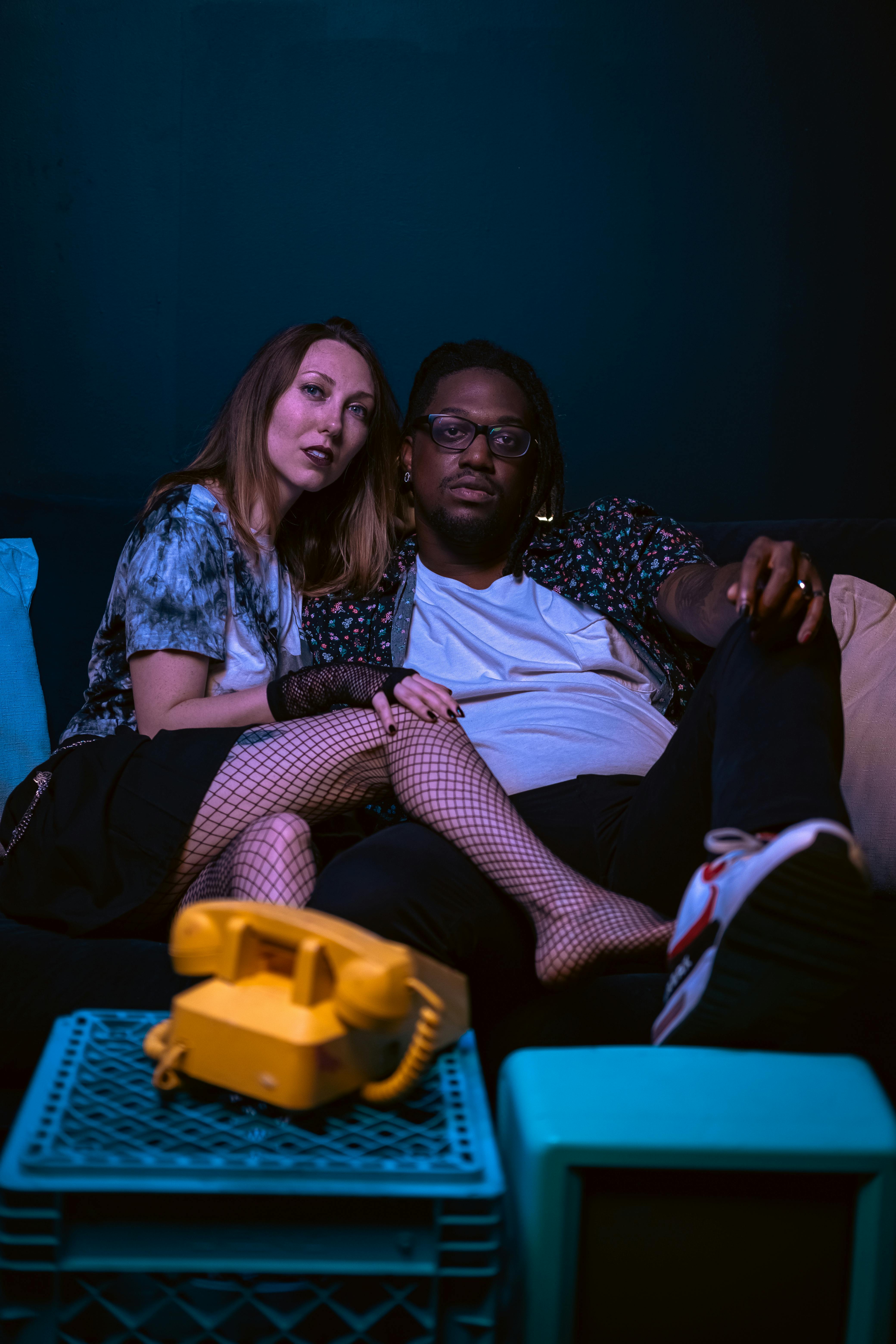 Couple Sitting on Sofa Together · Free Stock Photo