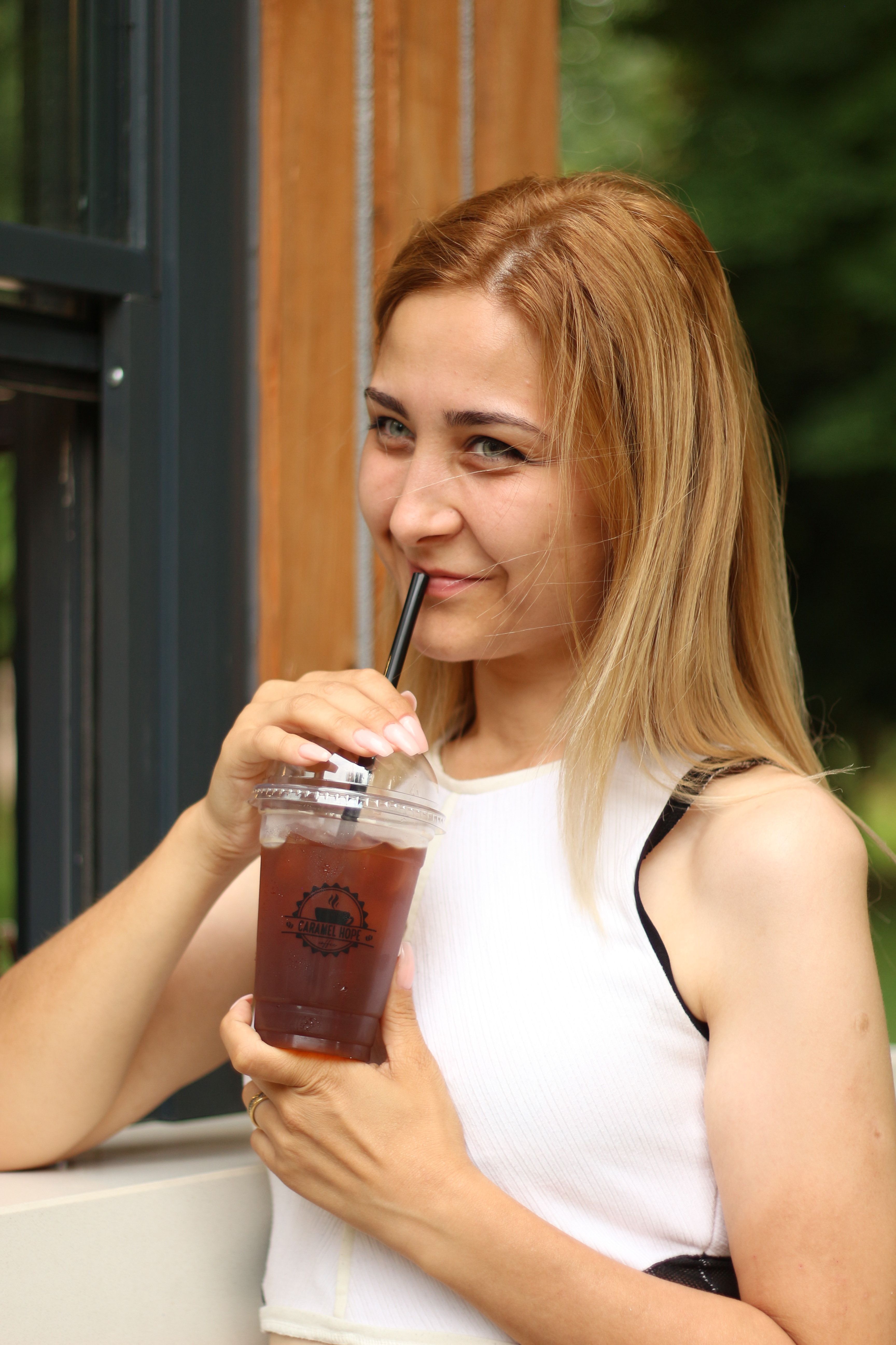 Woman Drinking from a Straw · Free Stock Photo