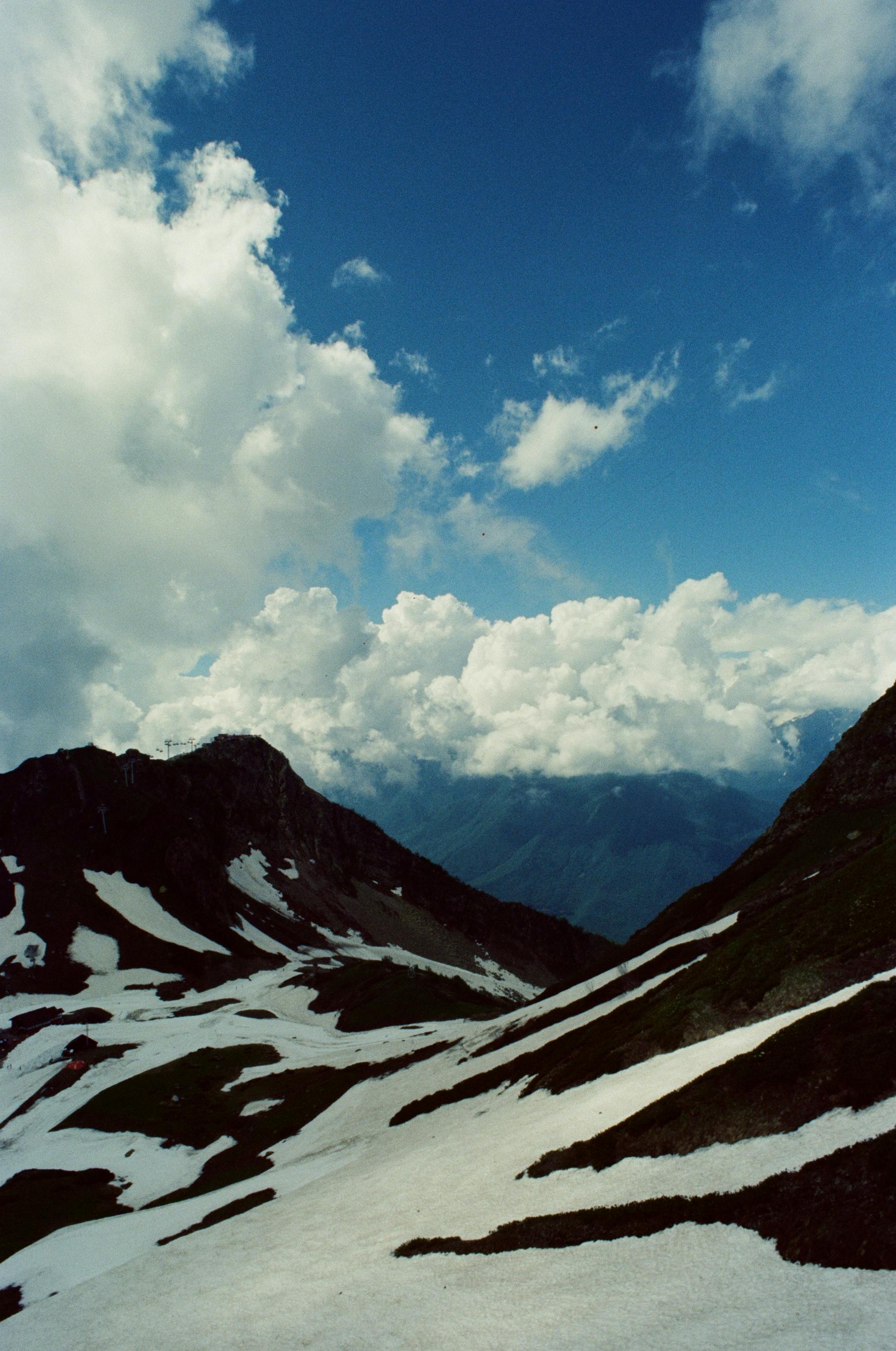 A Snowy Mountain under the Cloudy Sky · Free Stock Photo