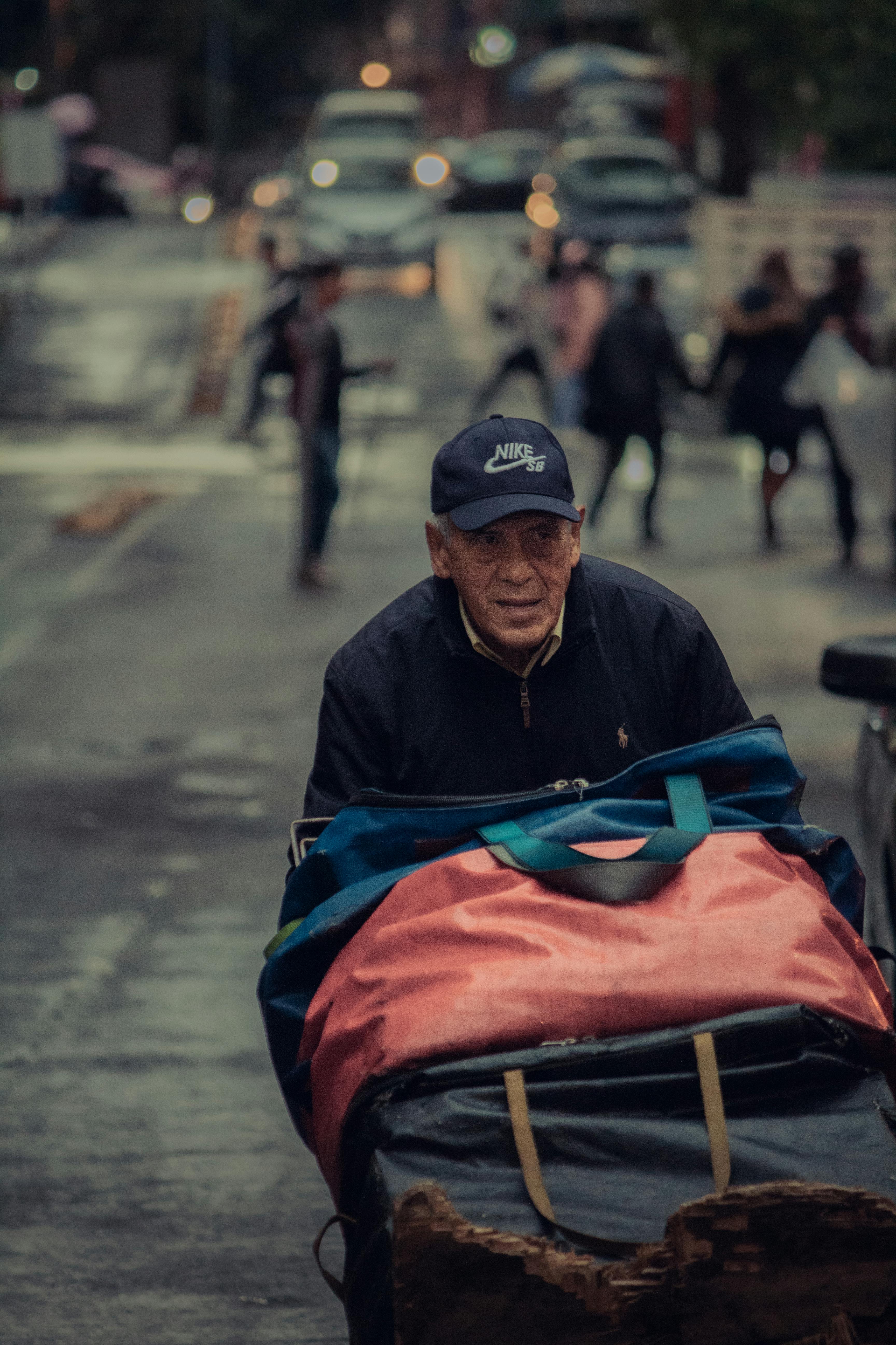 Elderly Man Wearing a Blue Cap Pushing a Cart on the Street · Free ...