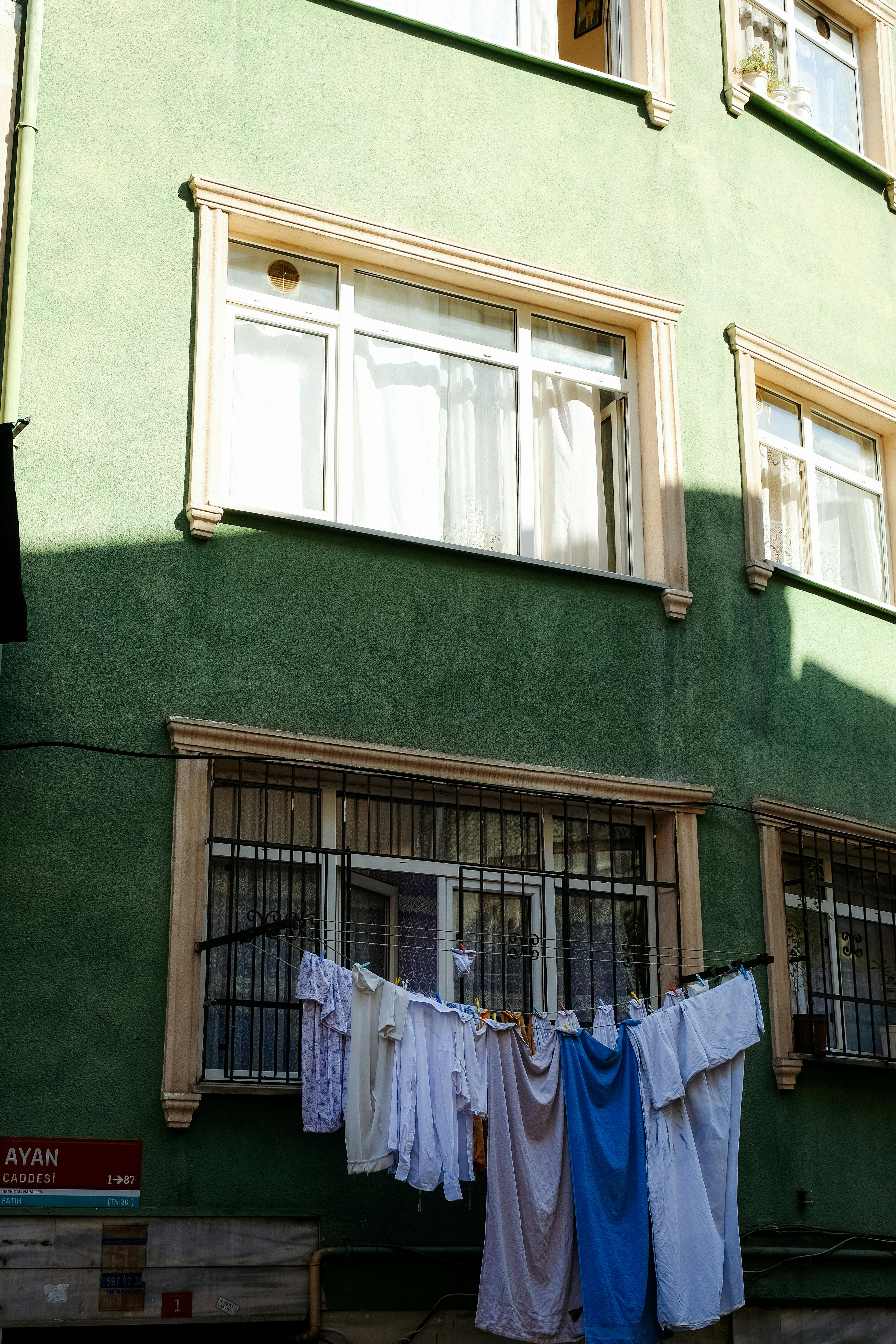 Laundry Drying in Front of Green Building · Free Stock Photo