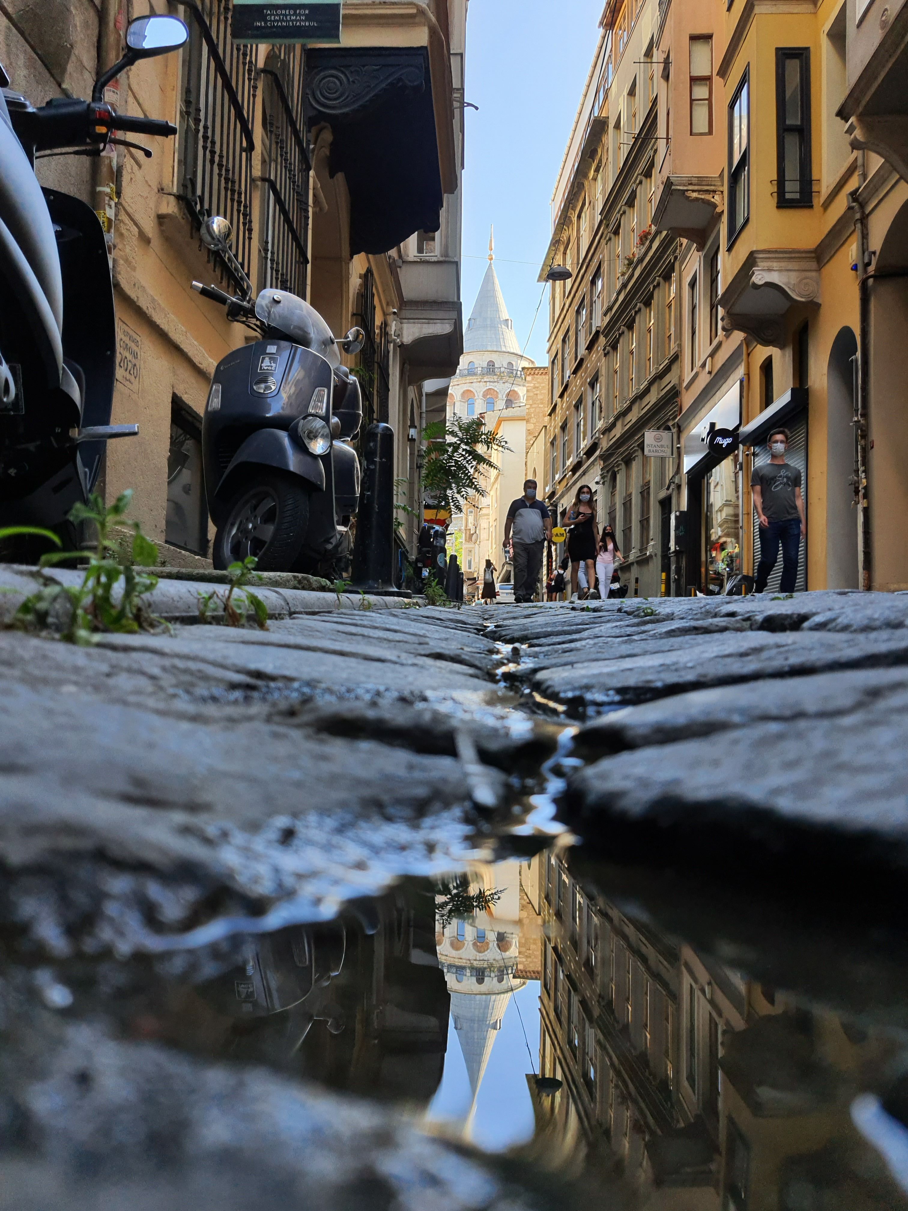 Puddle on Street with Galata Tower behind · Free Stock Photo