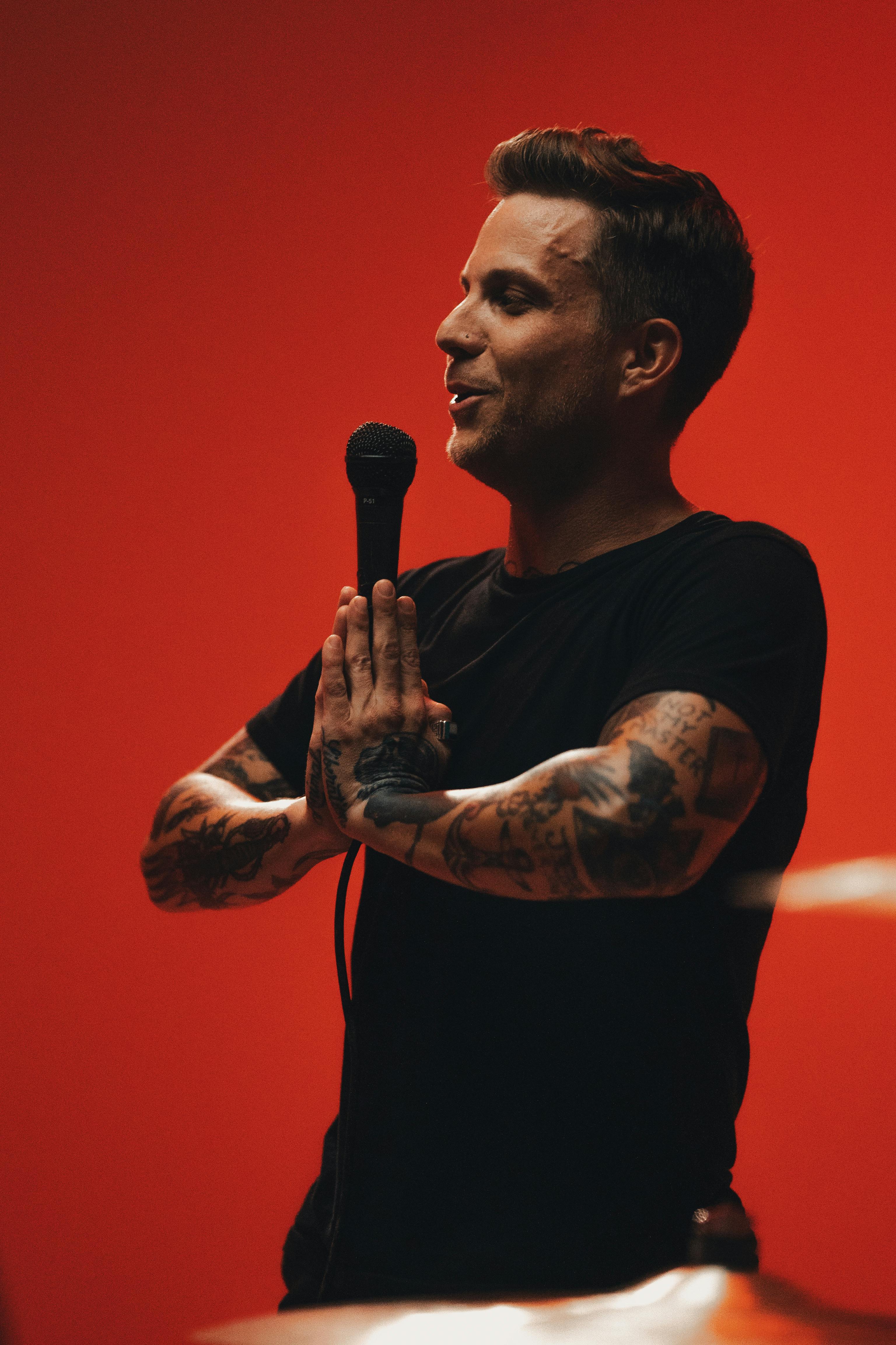 Woman in Black T-shirt Holding Microphone · Free Stock Photo