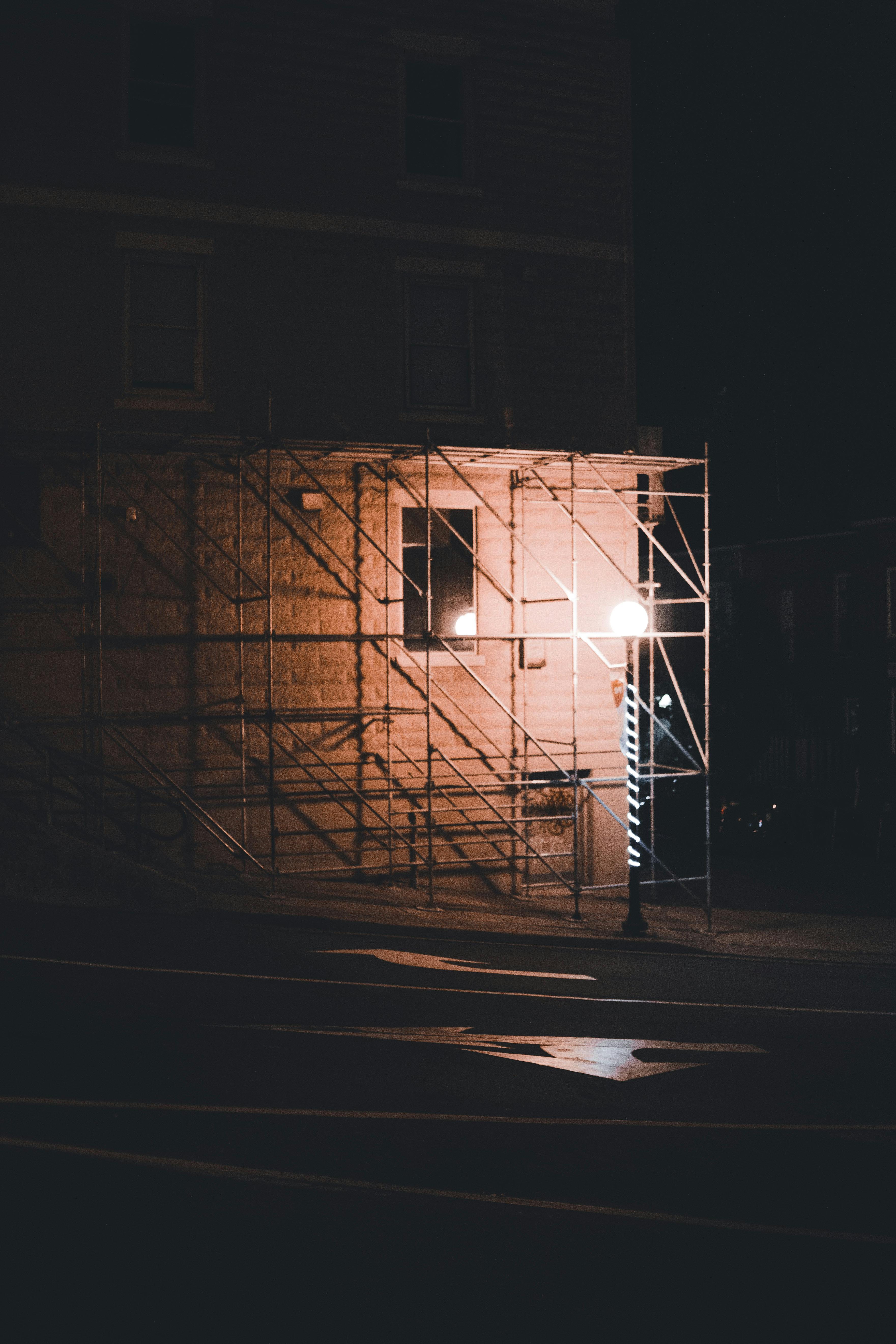 A Building with a Scaffolding at Night · Free Stock Photo