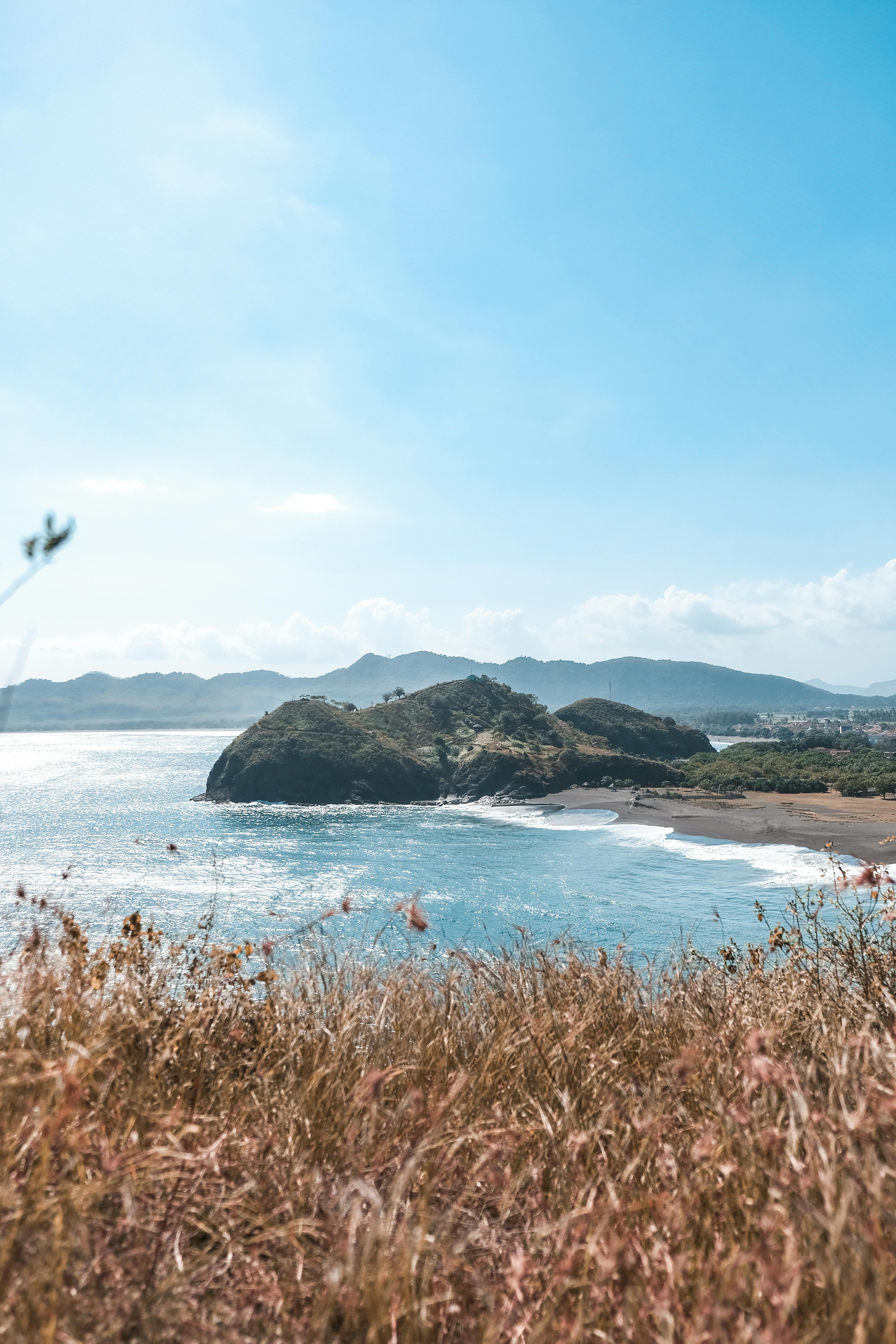 Photo of a Seashore with Rocks and a Sandy Beach · Free Stock Photo