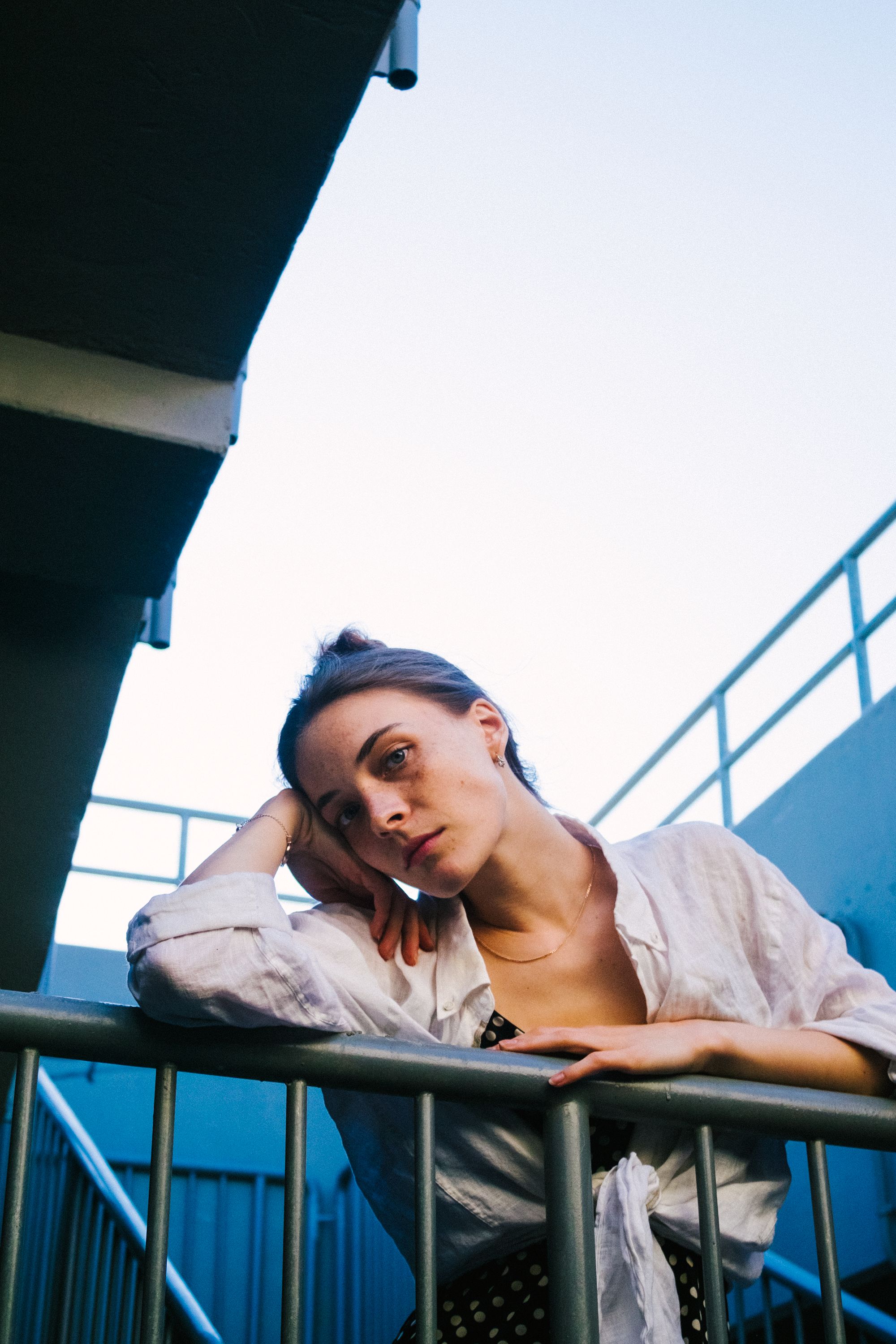 Woman in Shirt Leaning Against Light Pole · Free Stock Photo