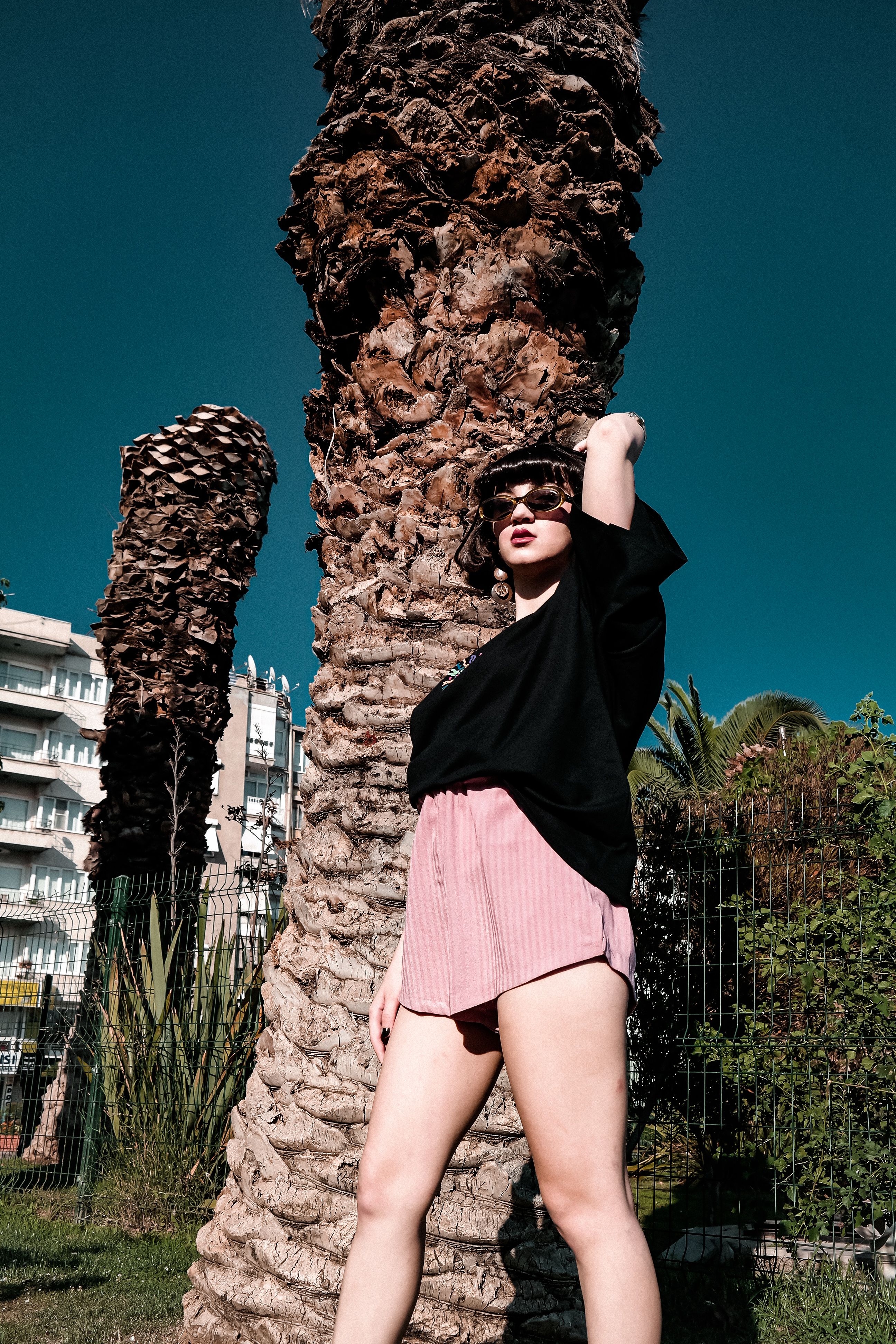 A Woman Standing by a Tree · Free Stock Photo