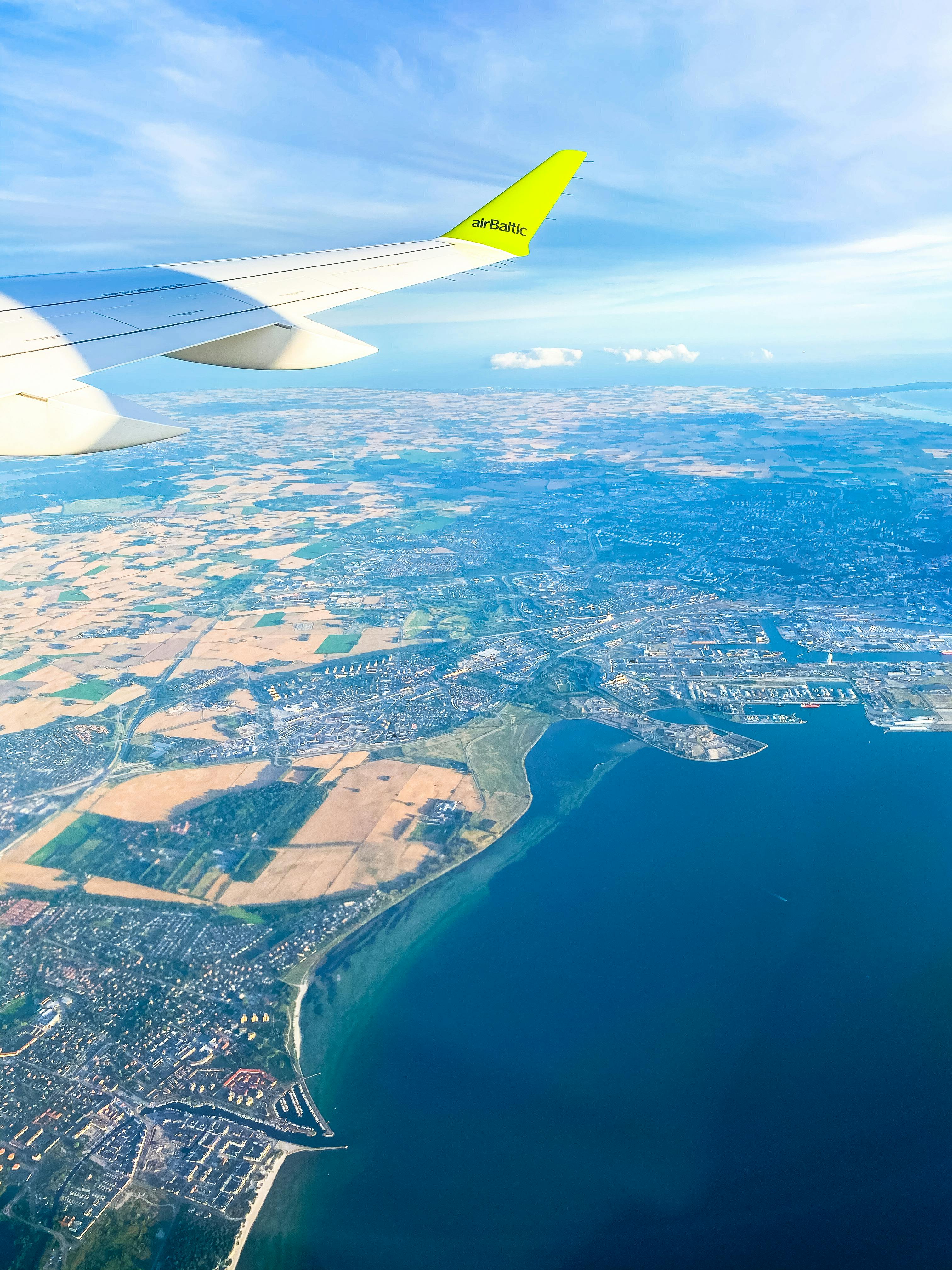 Red Plane Flying Under Blue Sky · Free Stock Photo