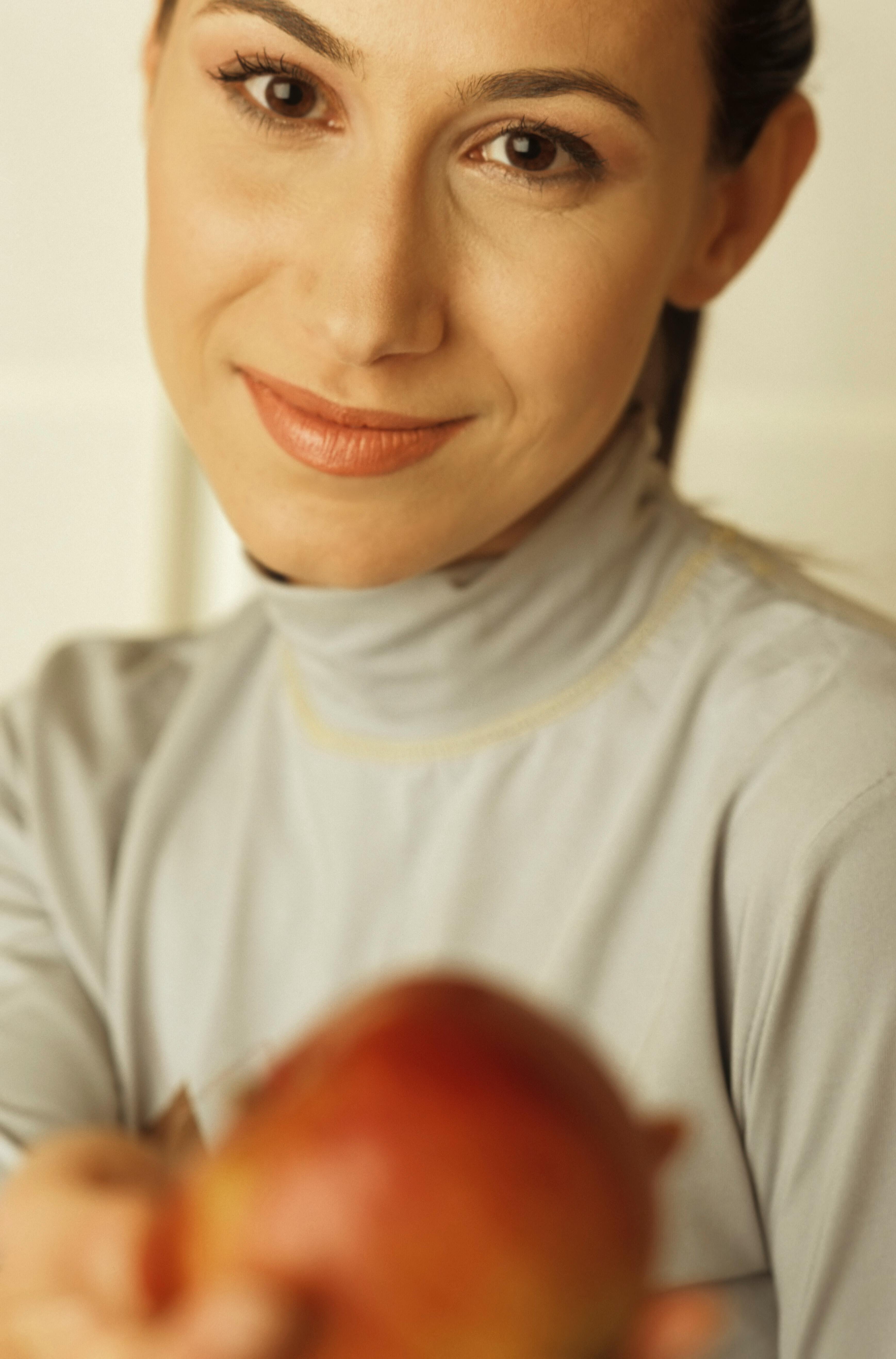 A Smiling Woman in Turtleneck Sweater · Free Stock Photo