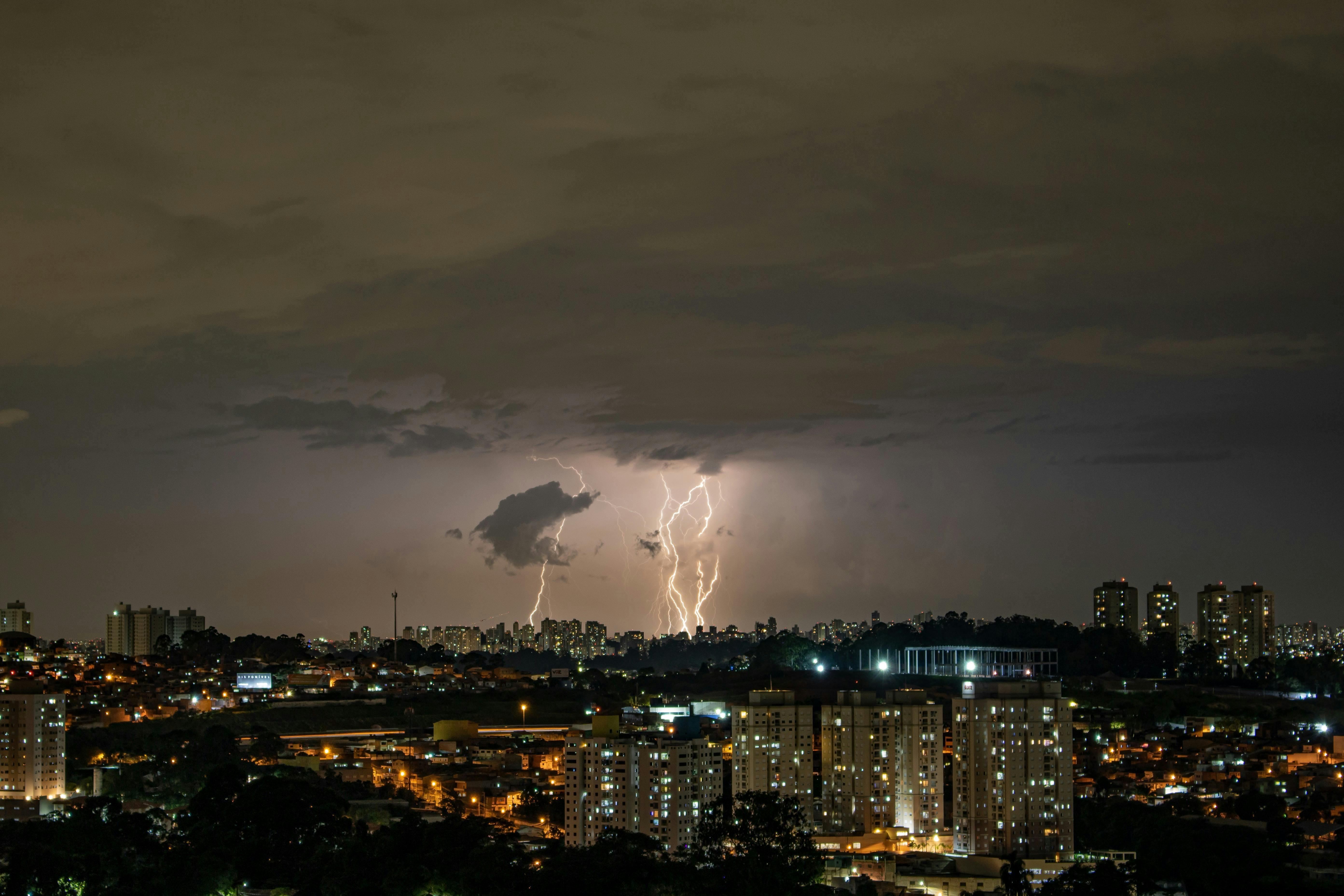 Lightning Phenomenon Near City And Ocean · Free Stock Photo