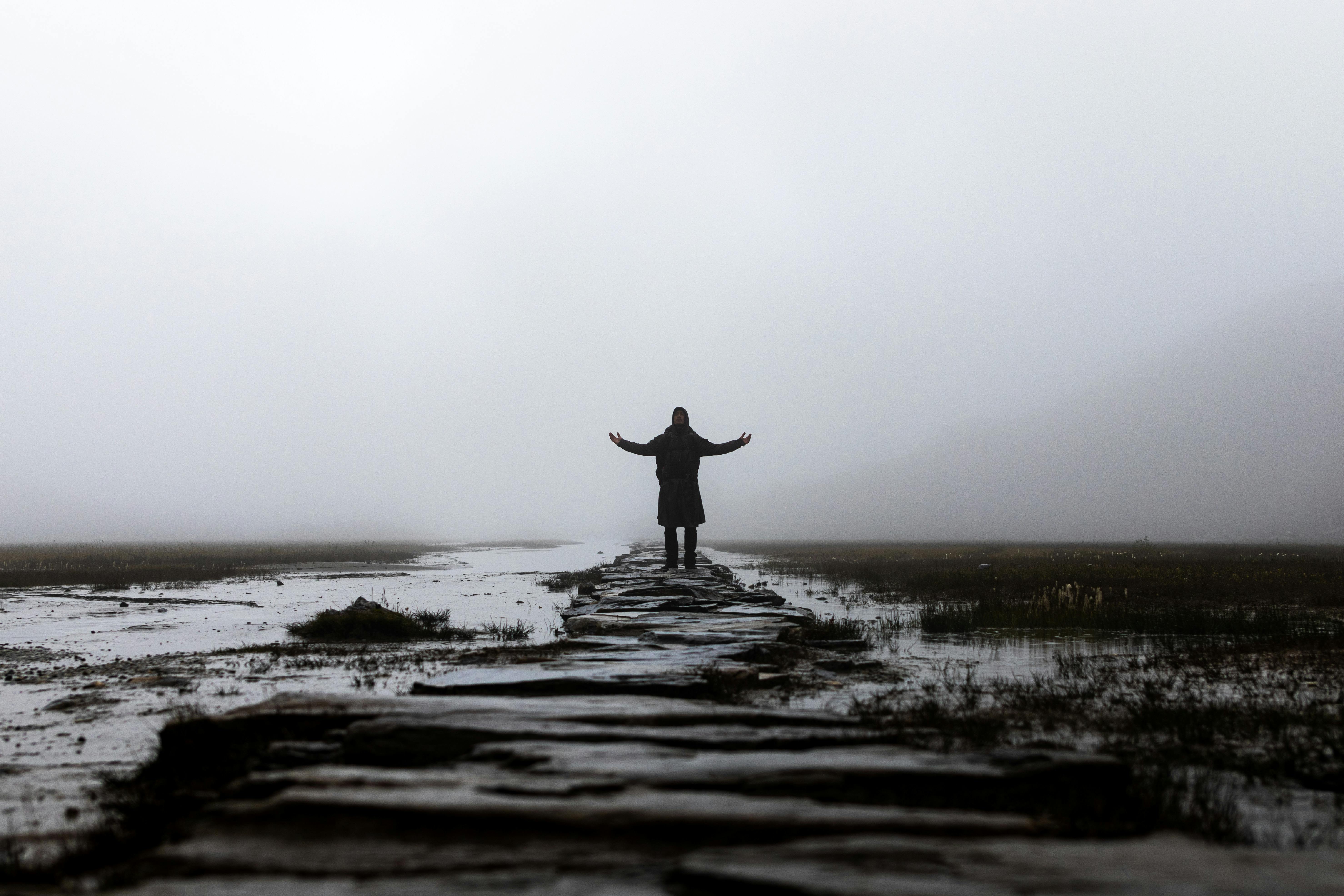 Woman in a Long Vintage Dress Holding a Lit Candle Outside in Fog ...