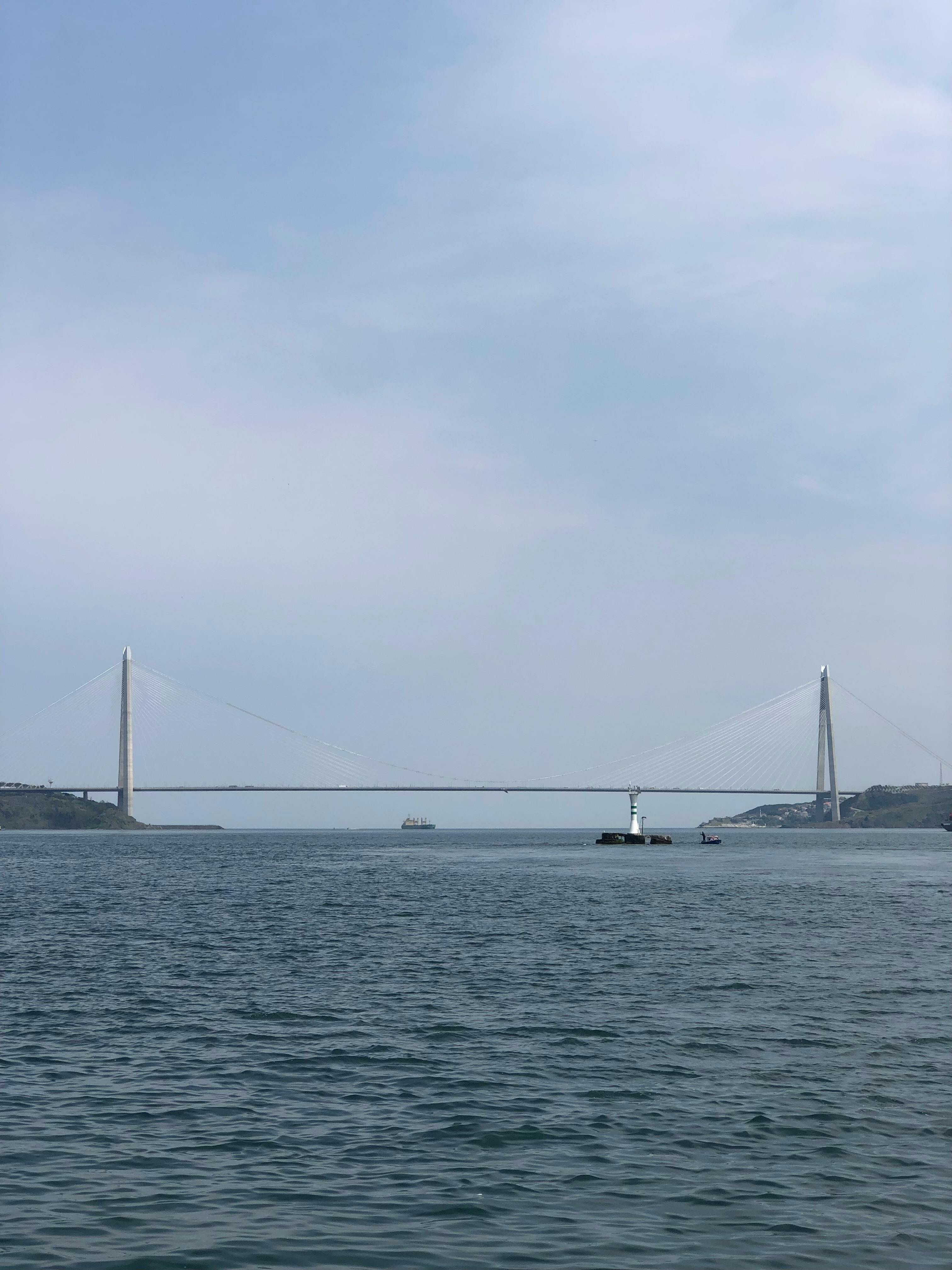Bridge Over a Body of Water Under a Blue Sky · Free Stock Photo