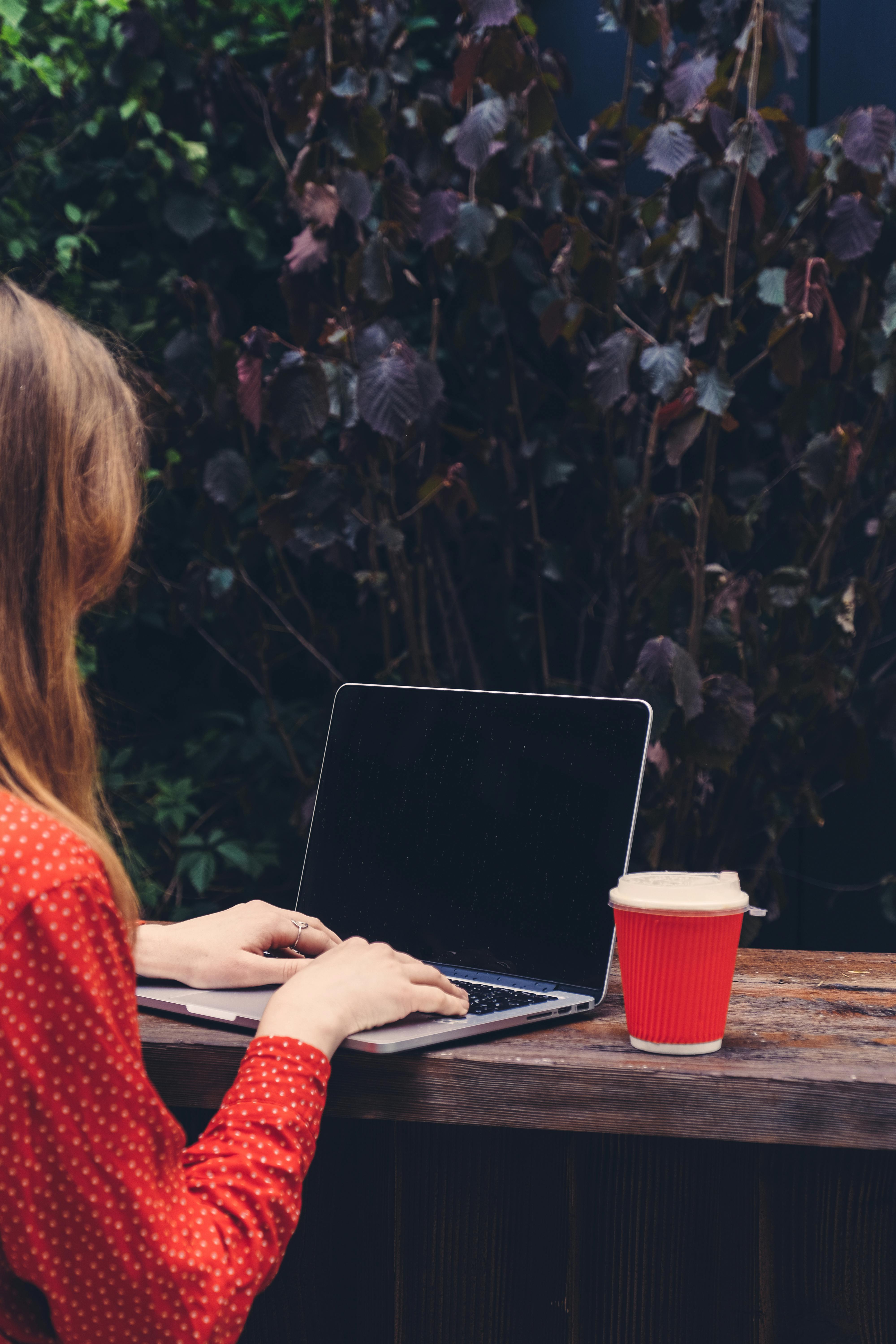 Freelancer Working on Laptop Outdoors · Free Stock Photo