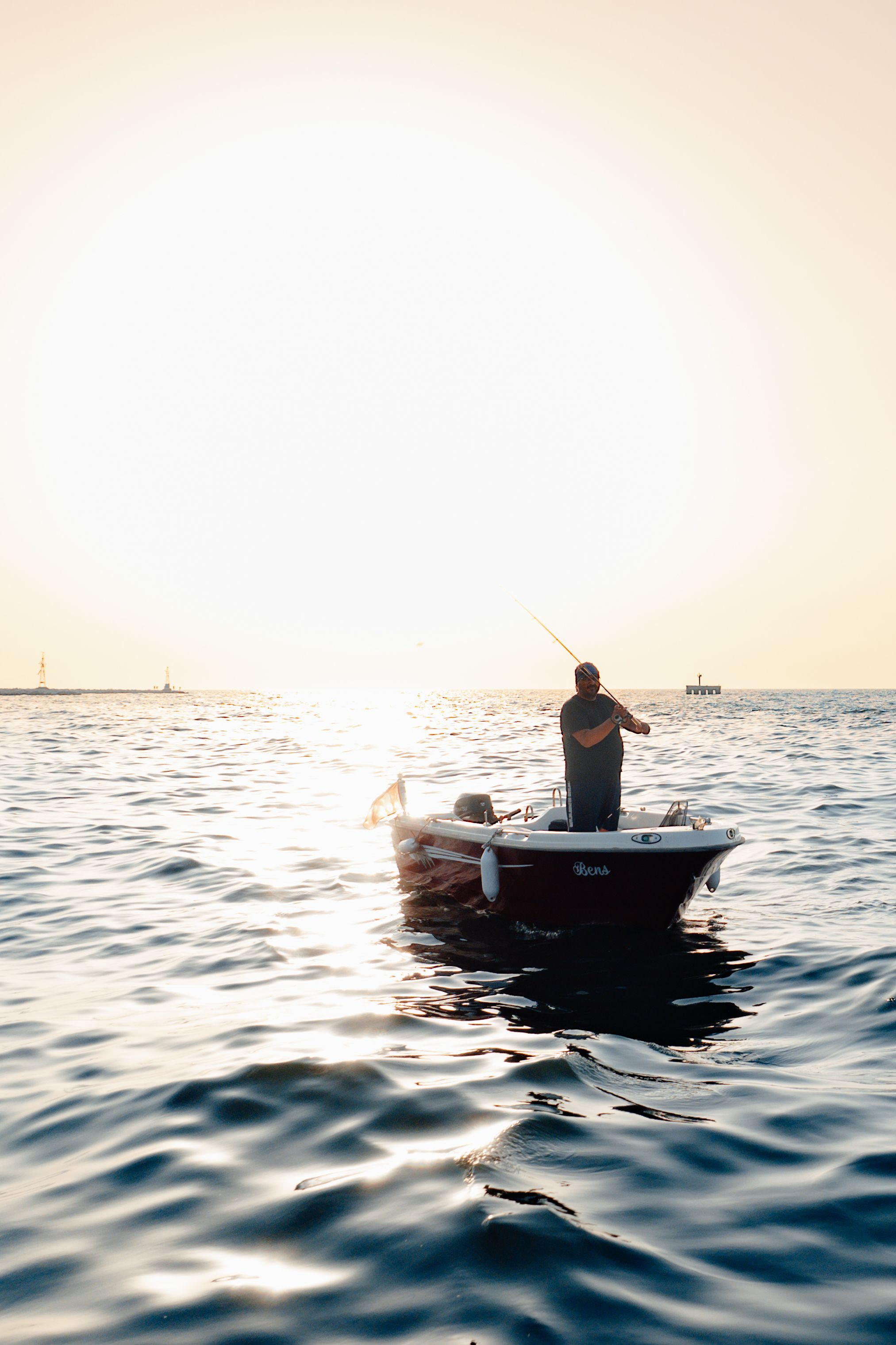 Fisherman on Boat and Sun behind · Free Stock Photo