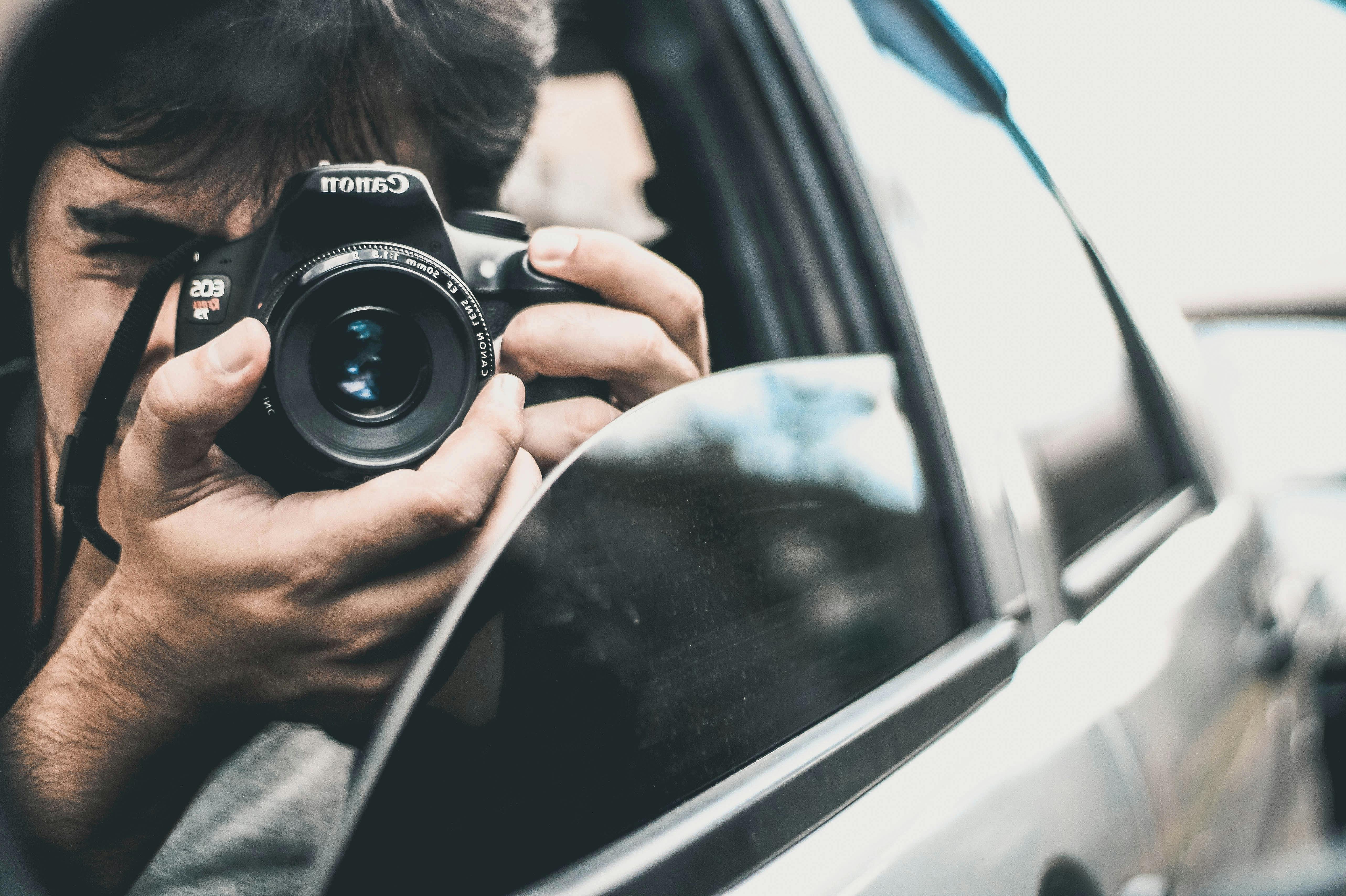 Man Holding Canon Camera Inside Car While Capturing a Photo · Free ...
