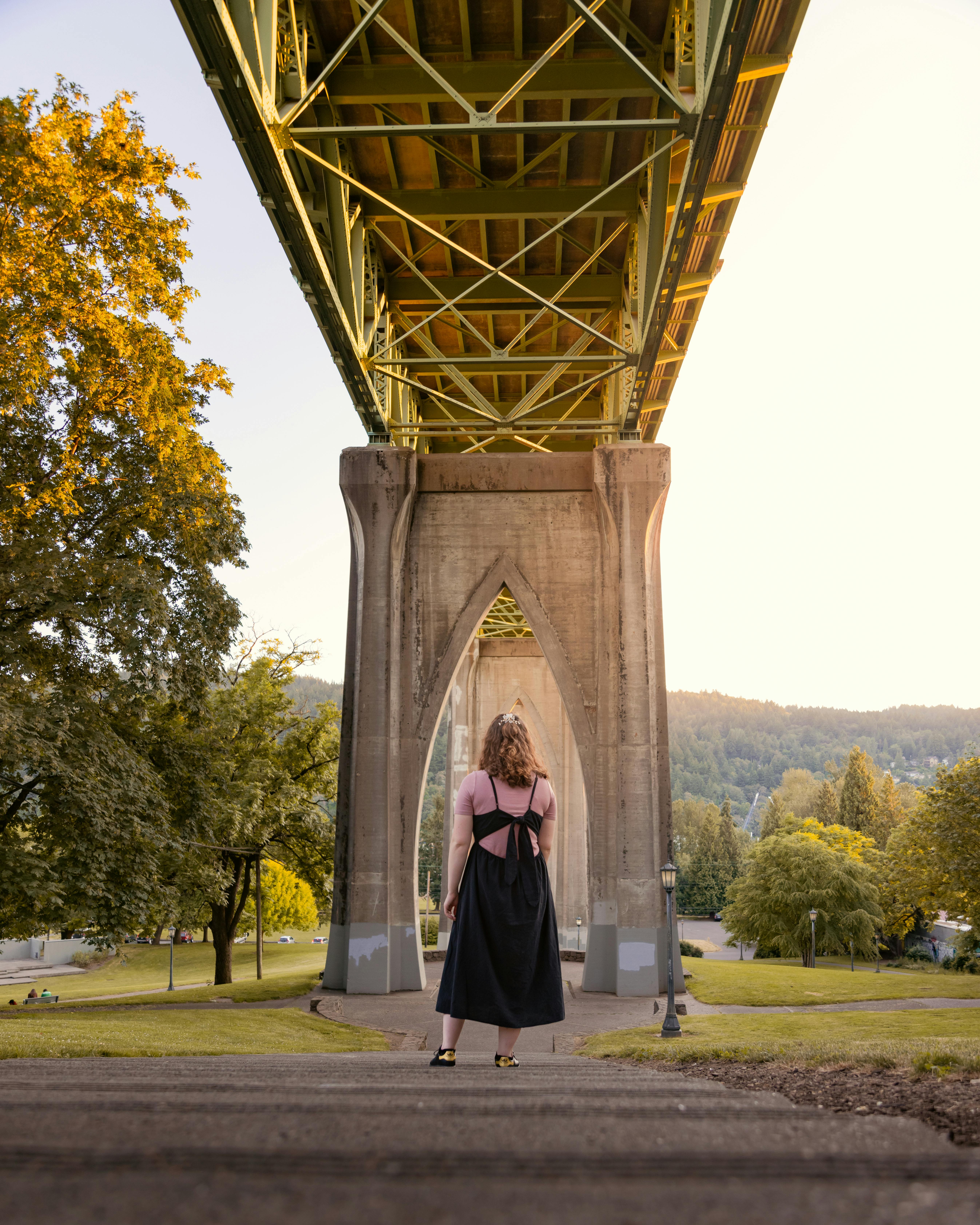Back View of a Woman Standing under a Bridge · Free Stock Photo