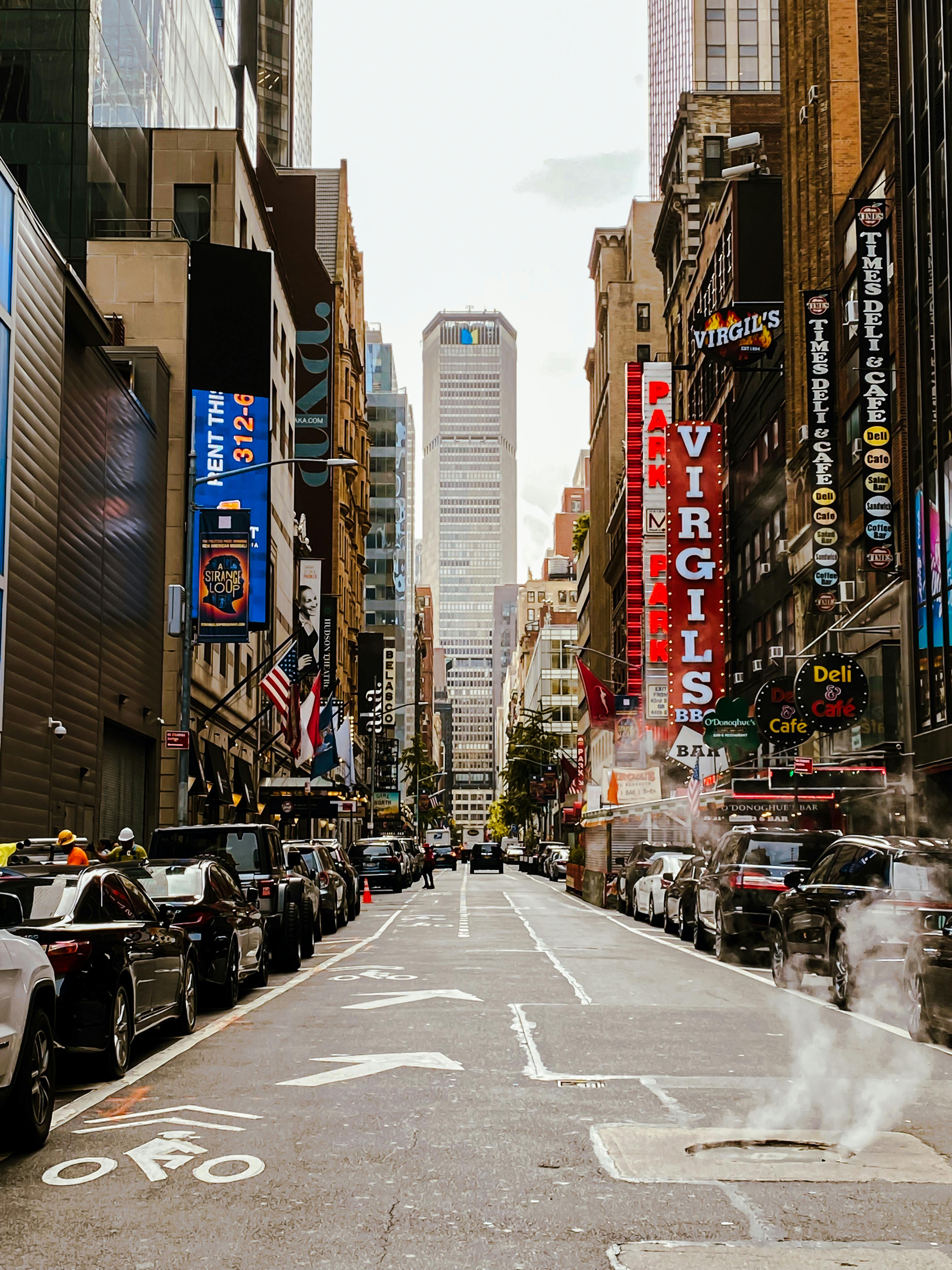 Parked Cars on a Street Between City Buildings · Free Stock Photo