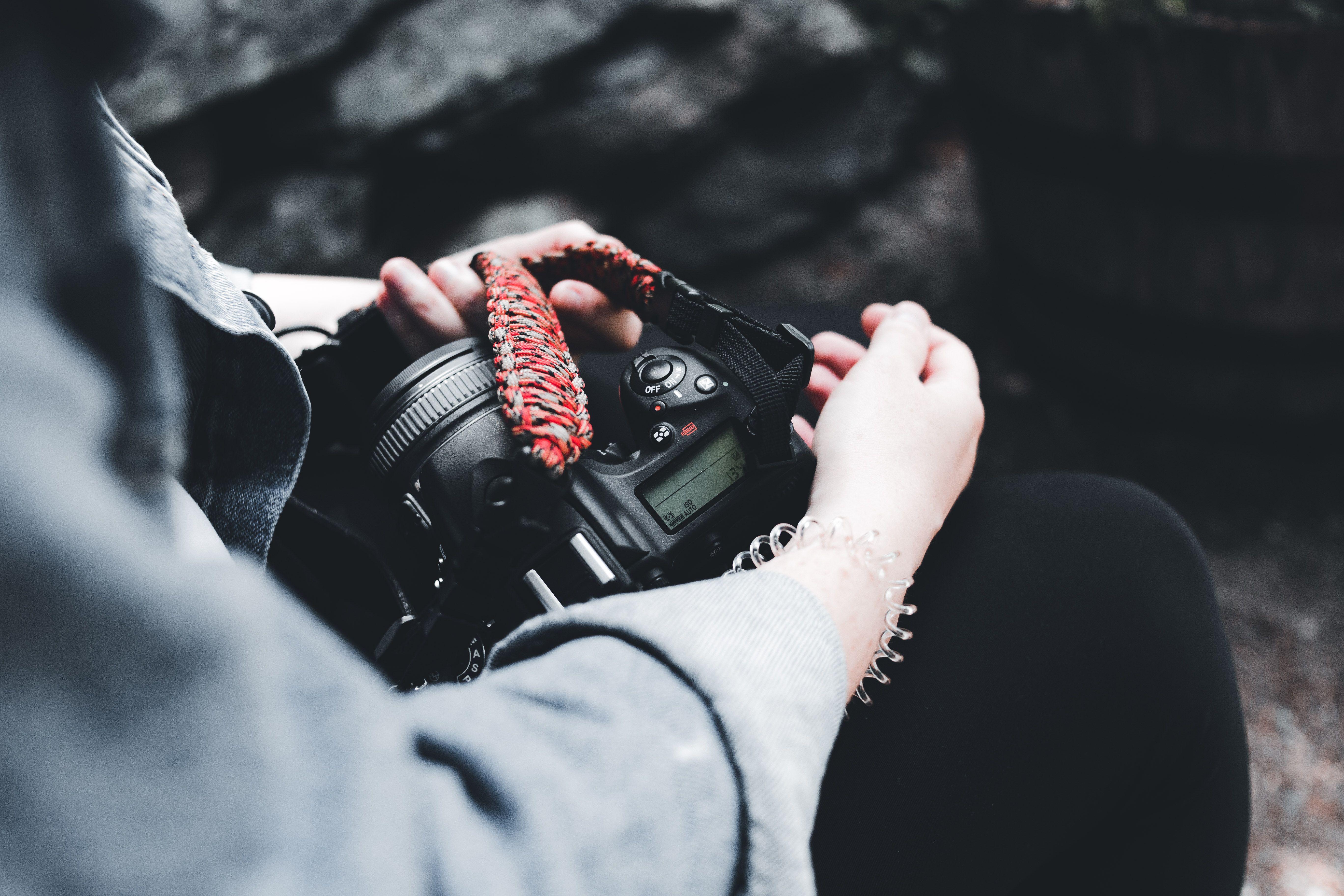 Close-up Photo of Woman Viewing Photos from Her Camera Near Body of ...