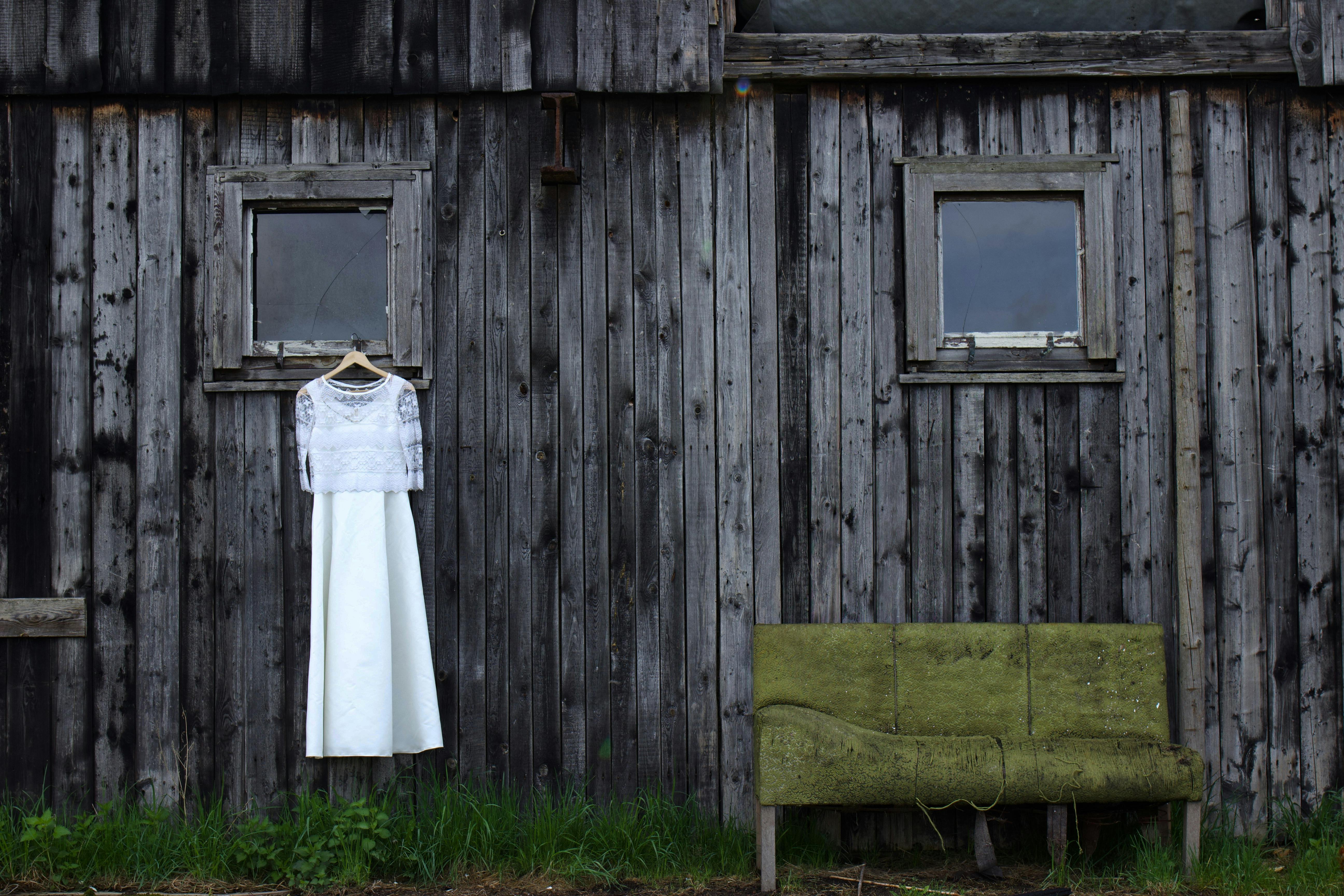 Wedding Dress Hanged on Wooden Building · Free Stock Photo