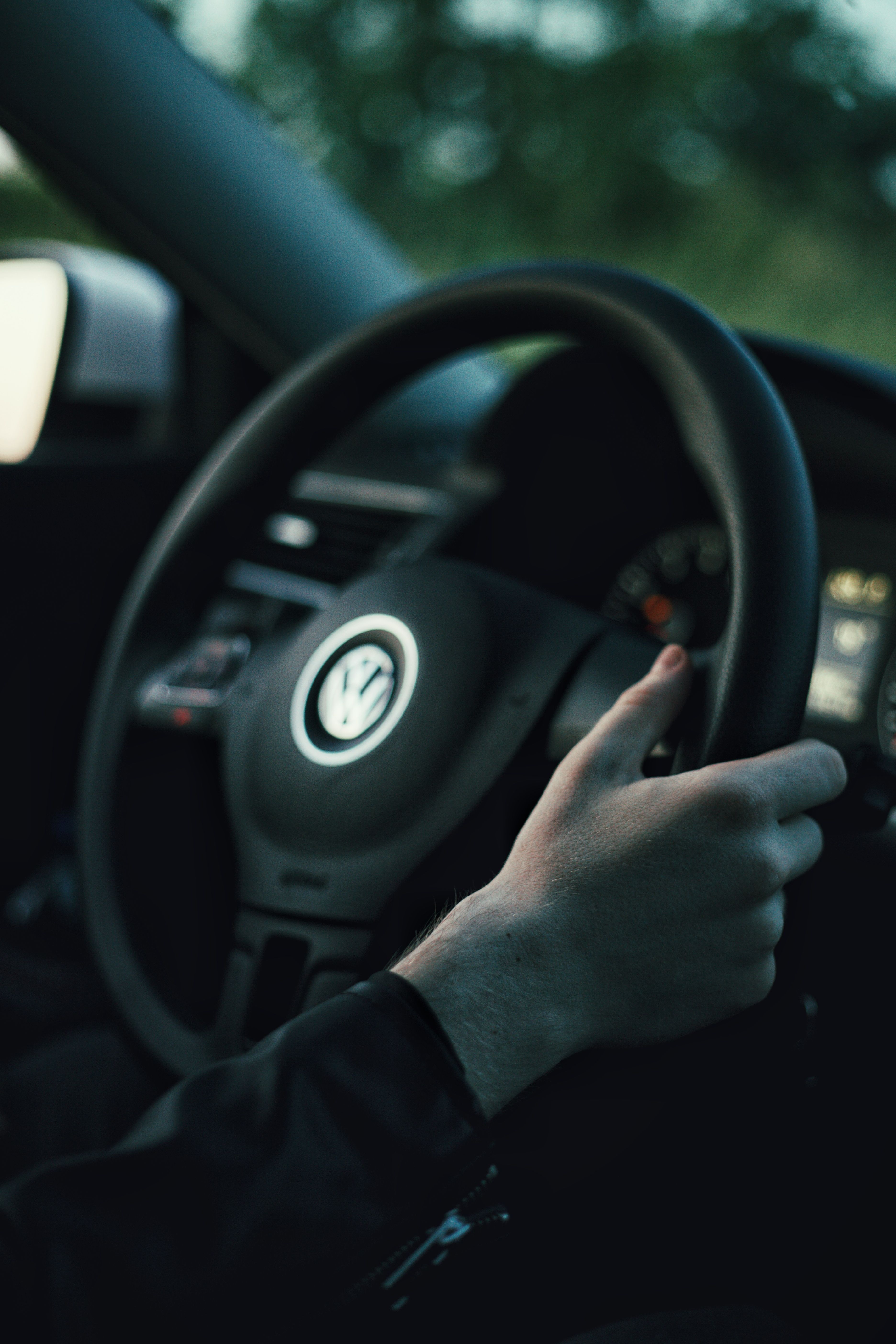 Man Holding a Steering Wheel of a Volkswagen Car with One Hand · Free ...