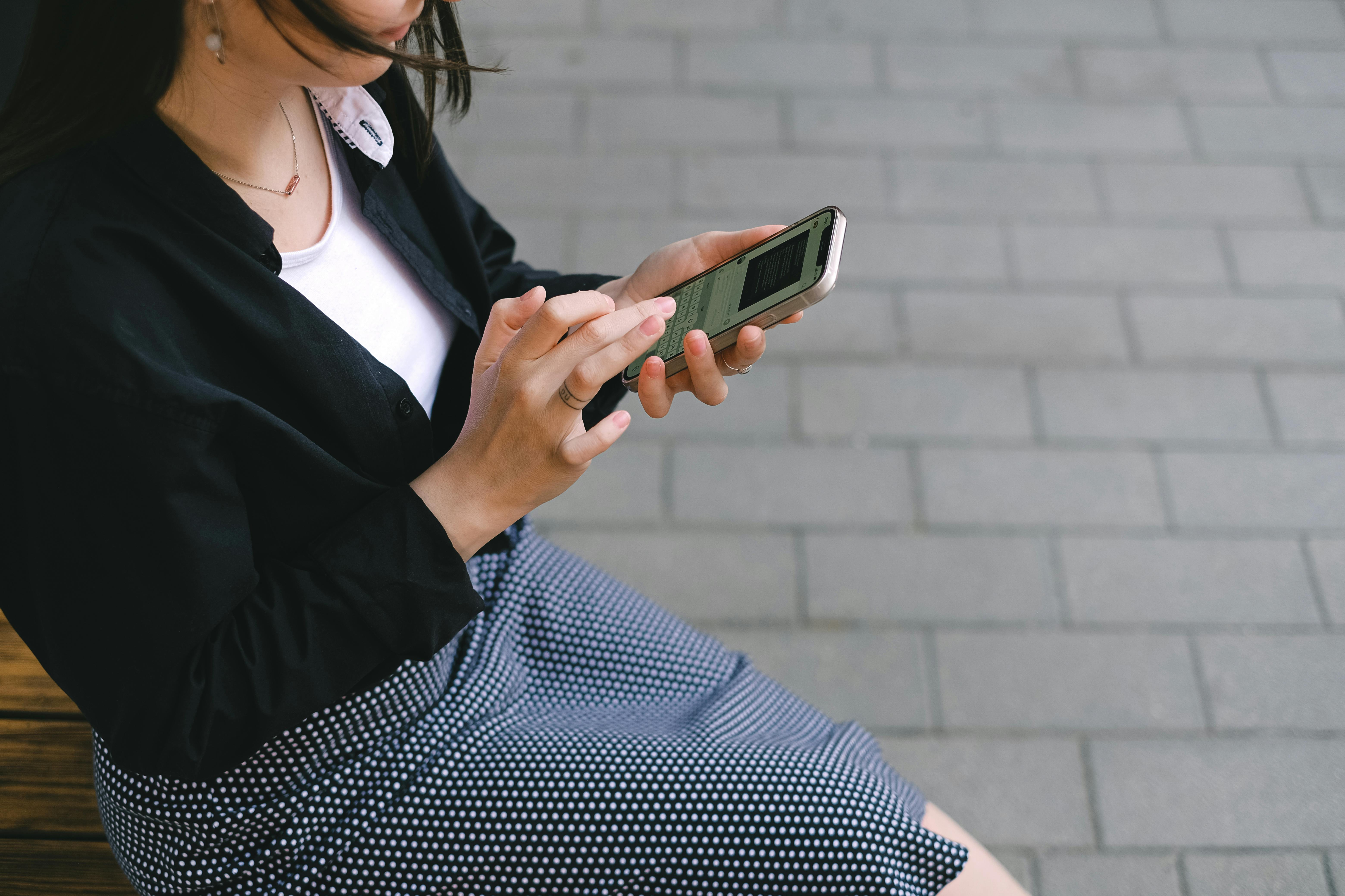 Woman Using Smartphone Outdoors in Urban Area · Free Stock Photo
