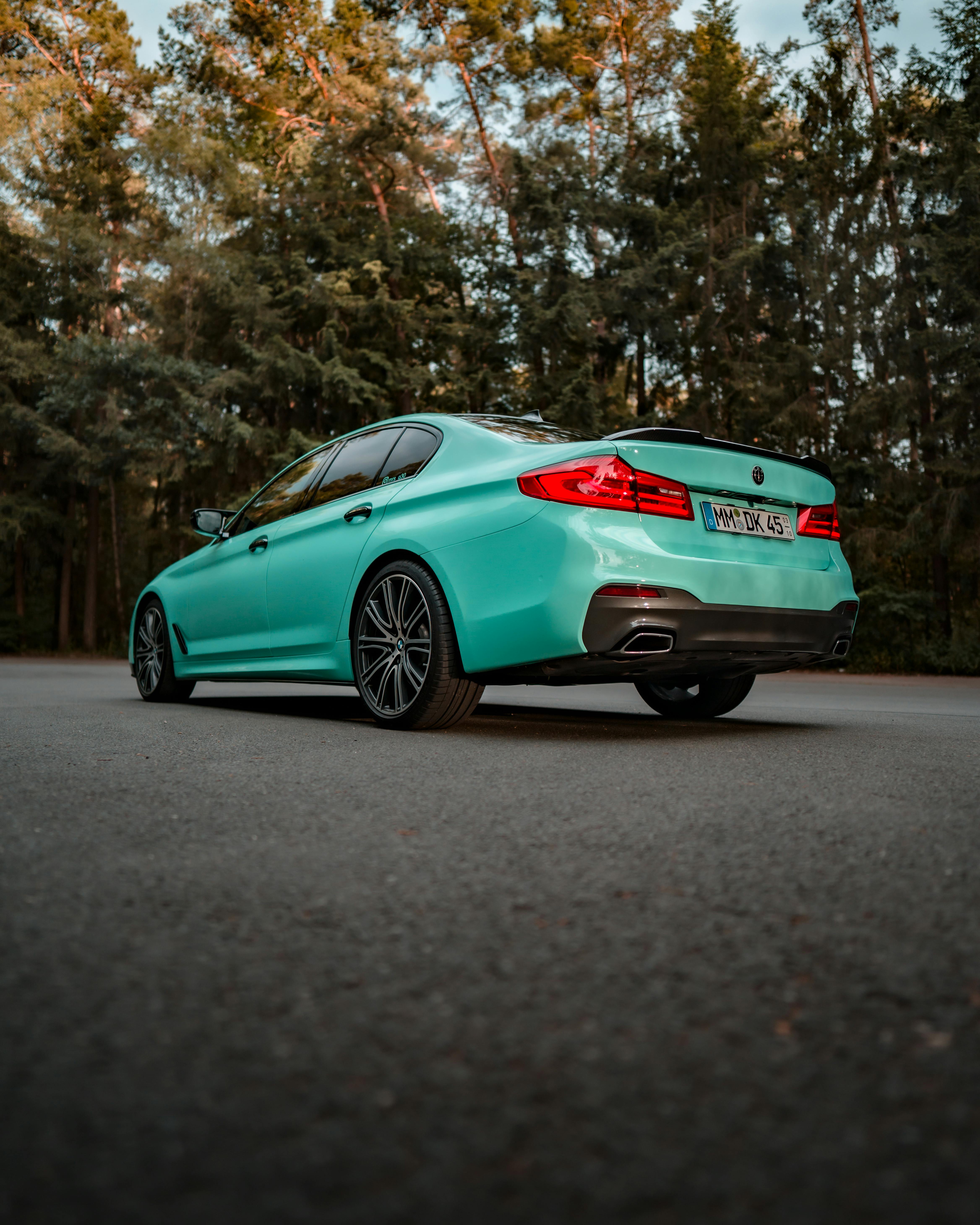 A Teal Sedan Car Parked on the Road · Free Stock Photo