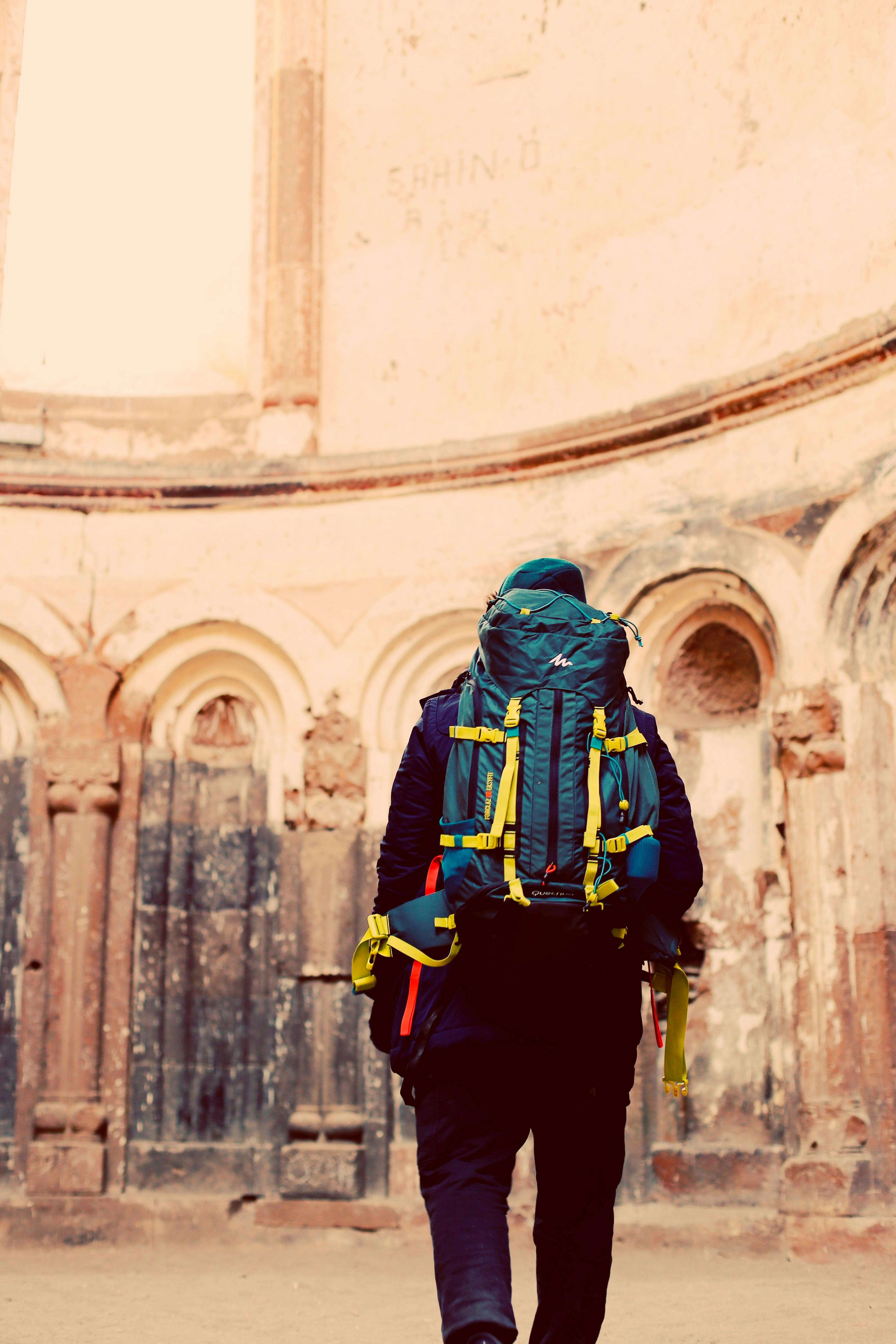 Back View Shot of a Person Carrying Backpack · Free Stock Photo
