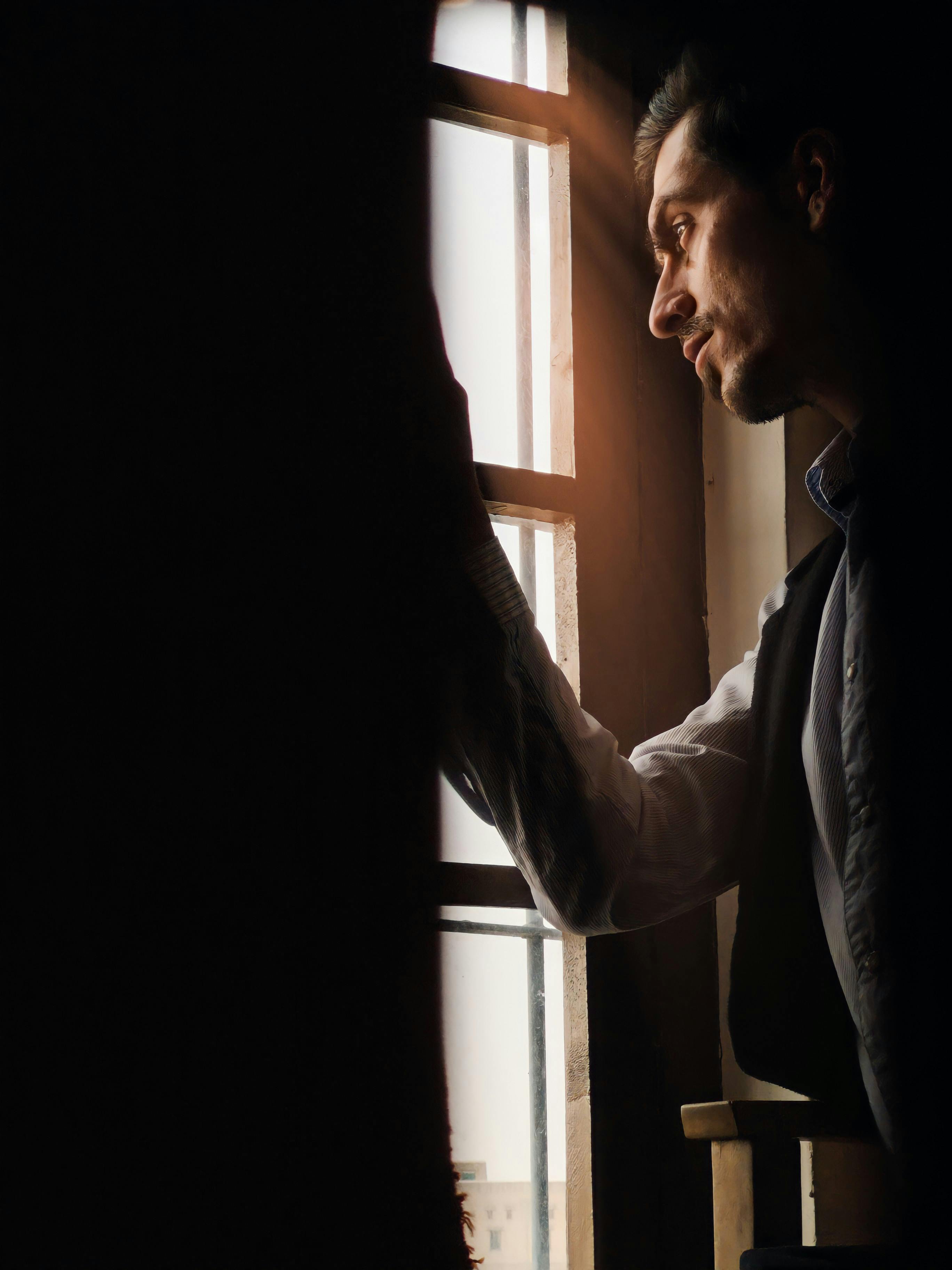 Silhouette of a Person Looking Outside the Window · Free Stock Photo