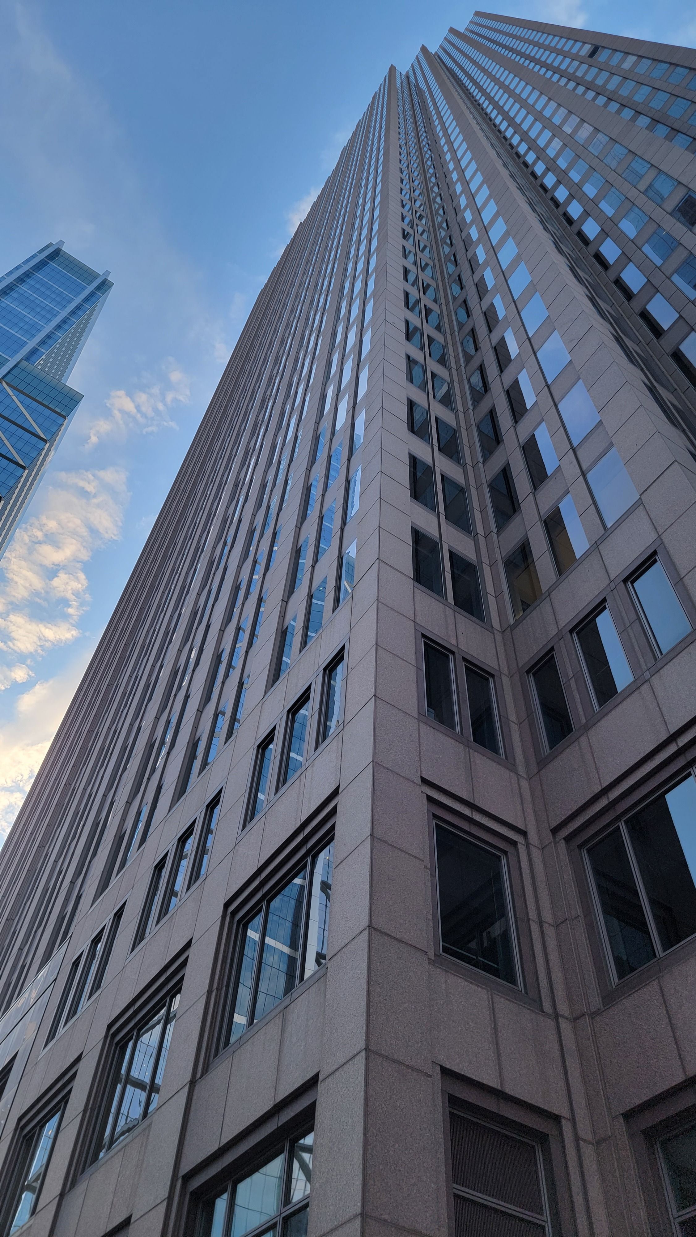 Back View of Man Looking Up at a Skyscraper · Free Stock Photo