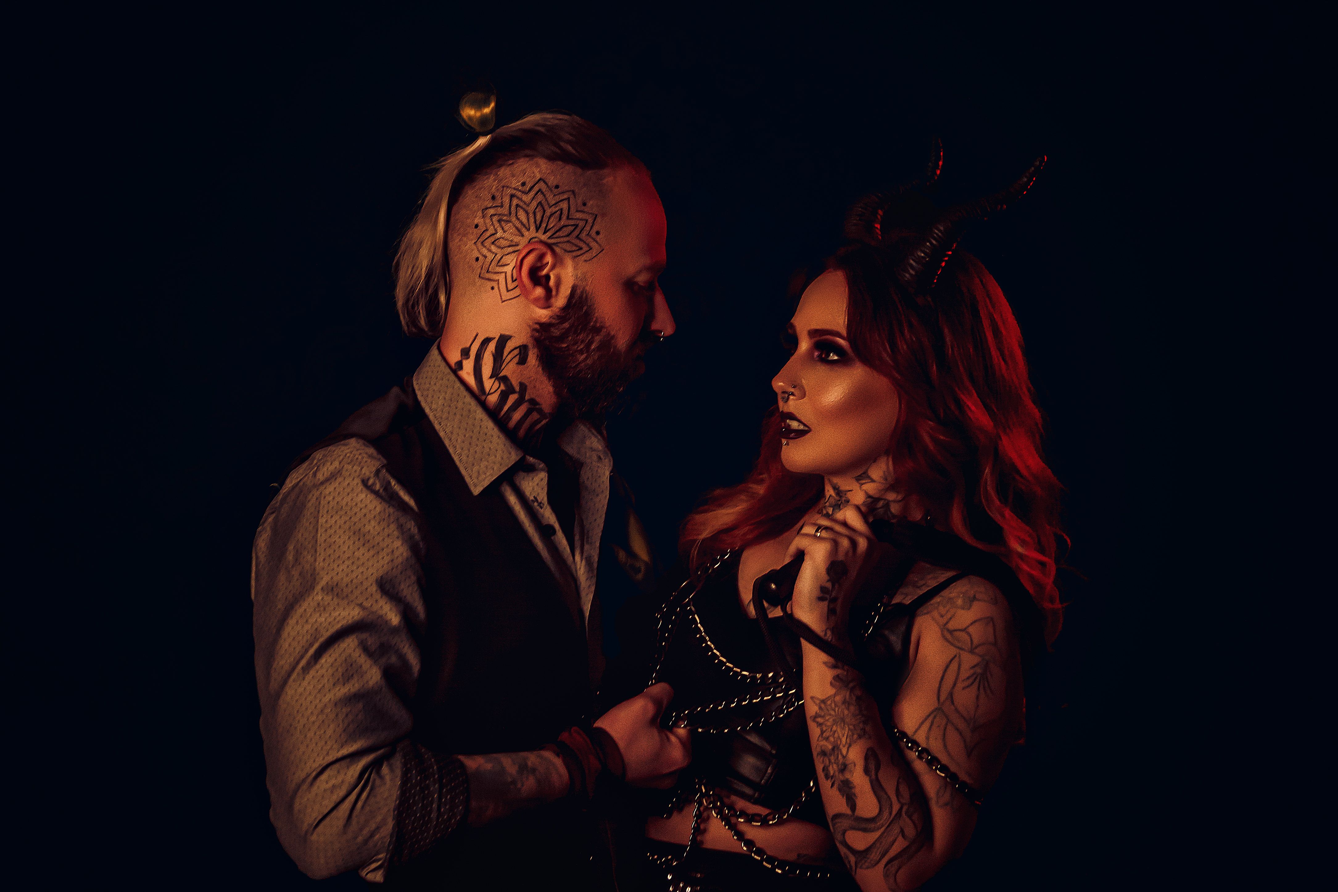 Couple with Tattoos in Black Horror Costumes · Free Stock Photo