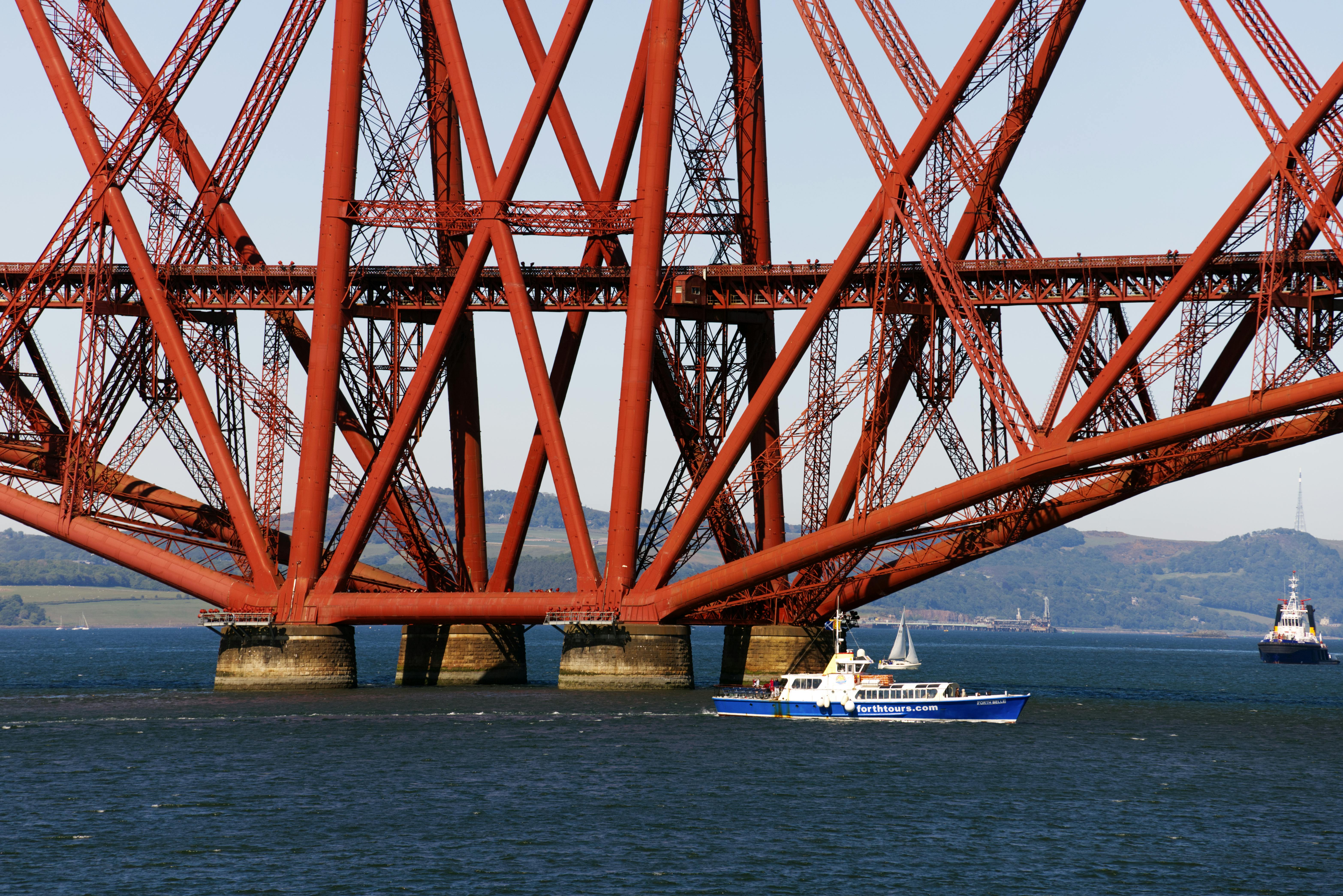 Boats under the Forth Bridge in Scotland · Free Stock Photo