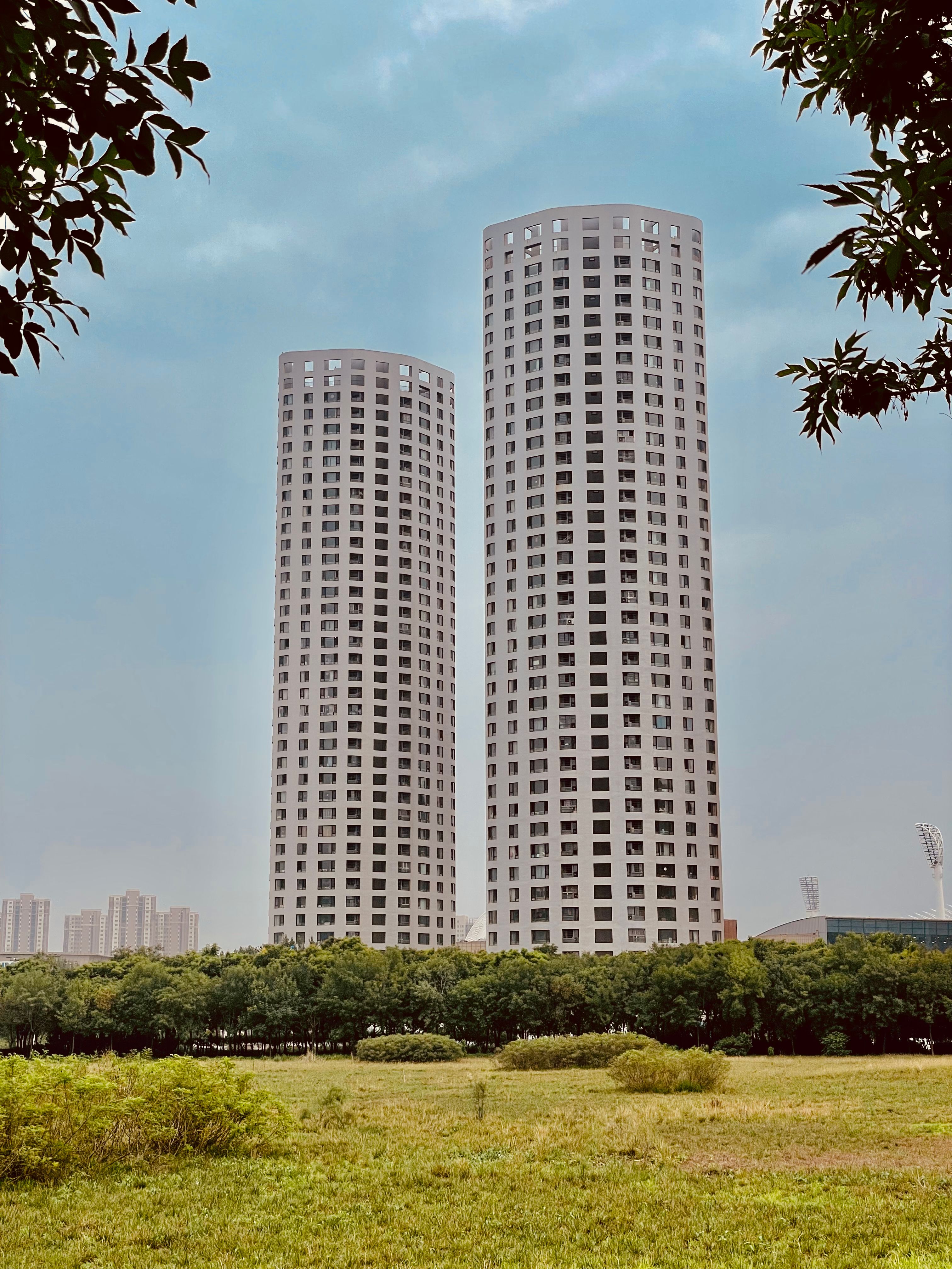 Green Grass Field Near High Rise Buildings · Free Stock Photo